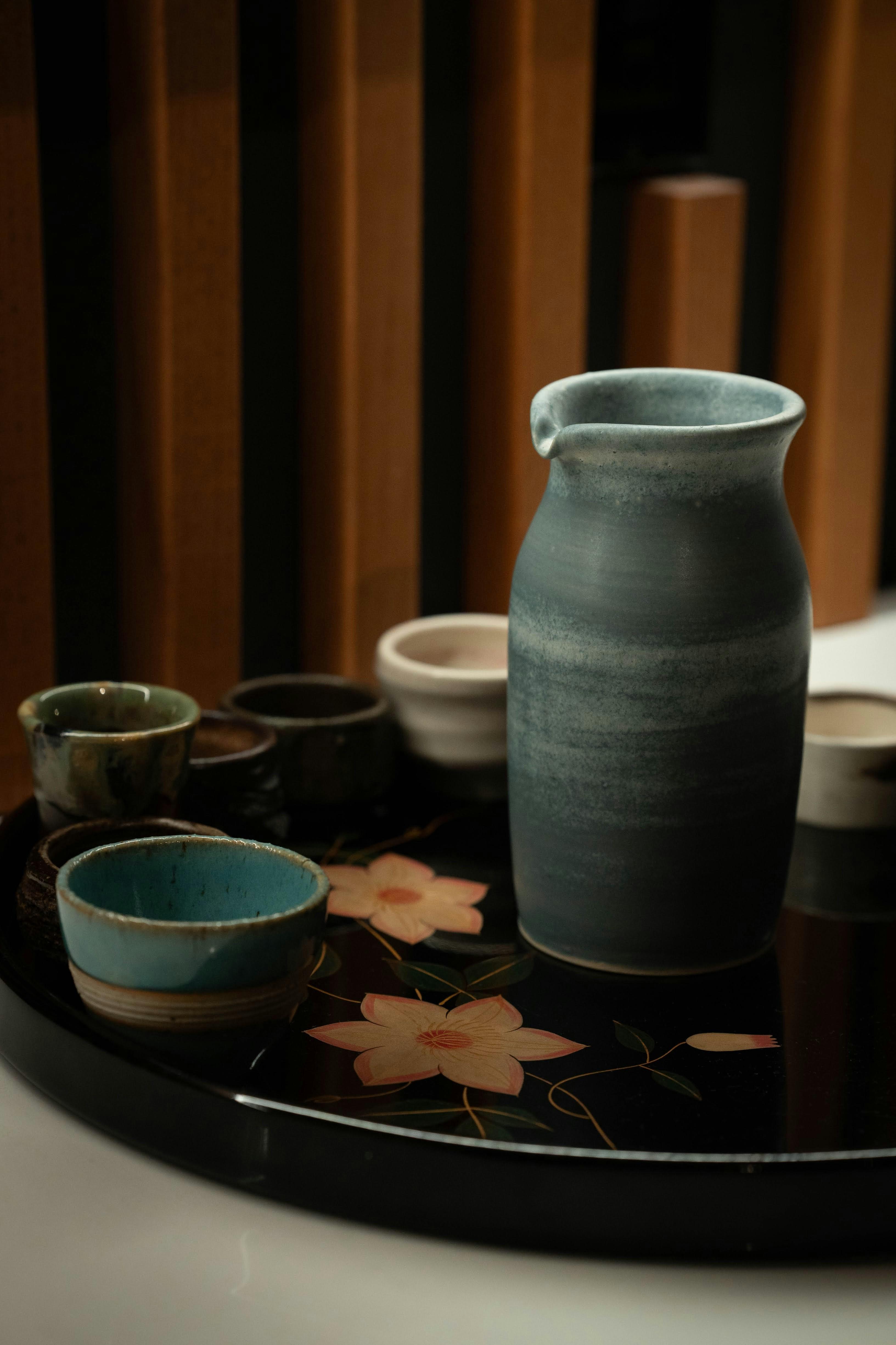 Sake set with ceramic cups and pitcher on tray