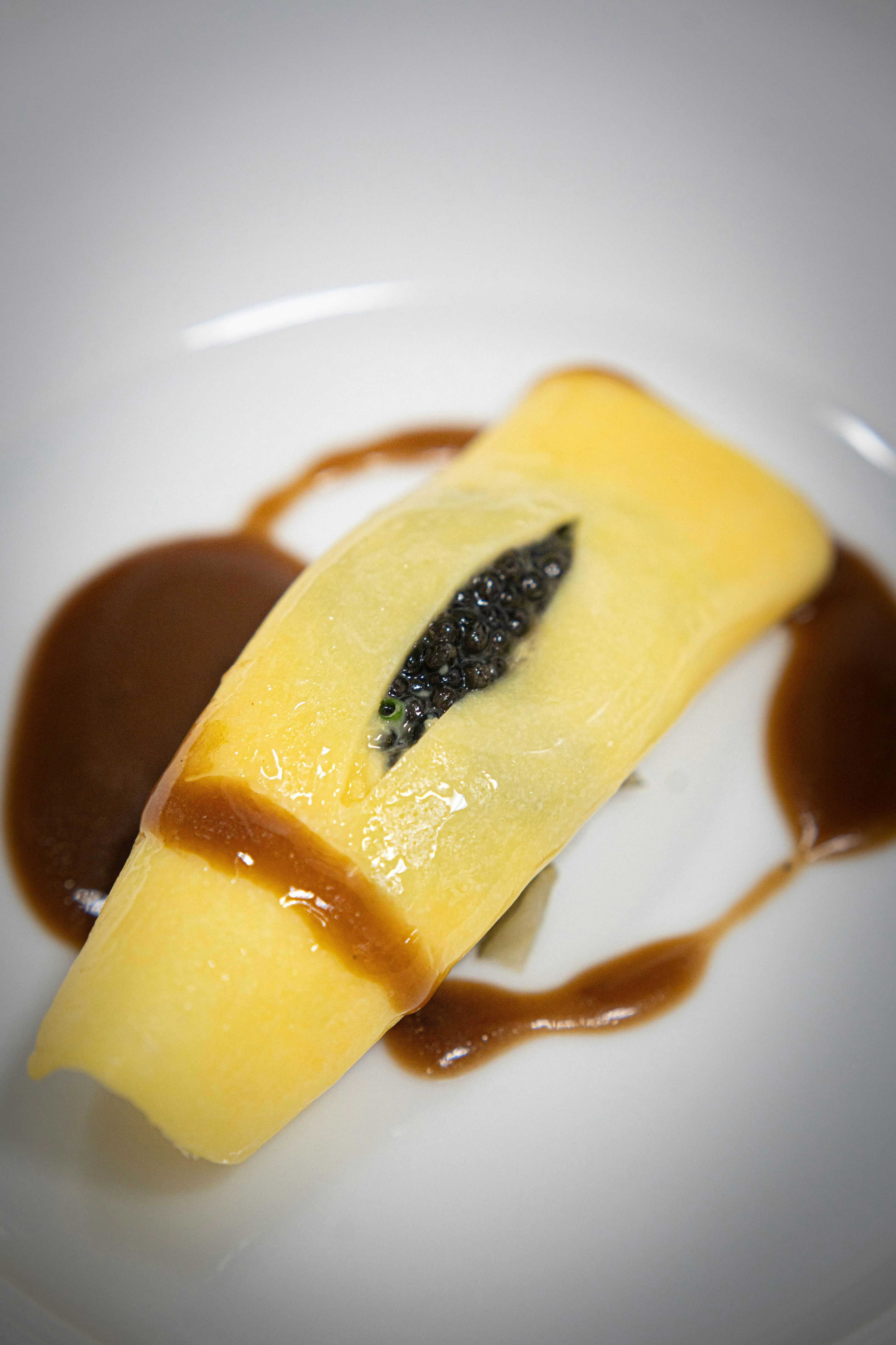 Golden Pastry Crescent Cradling a Midnight Berry Core