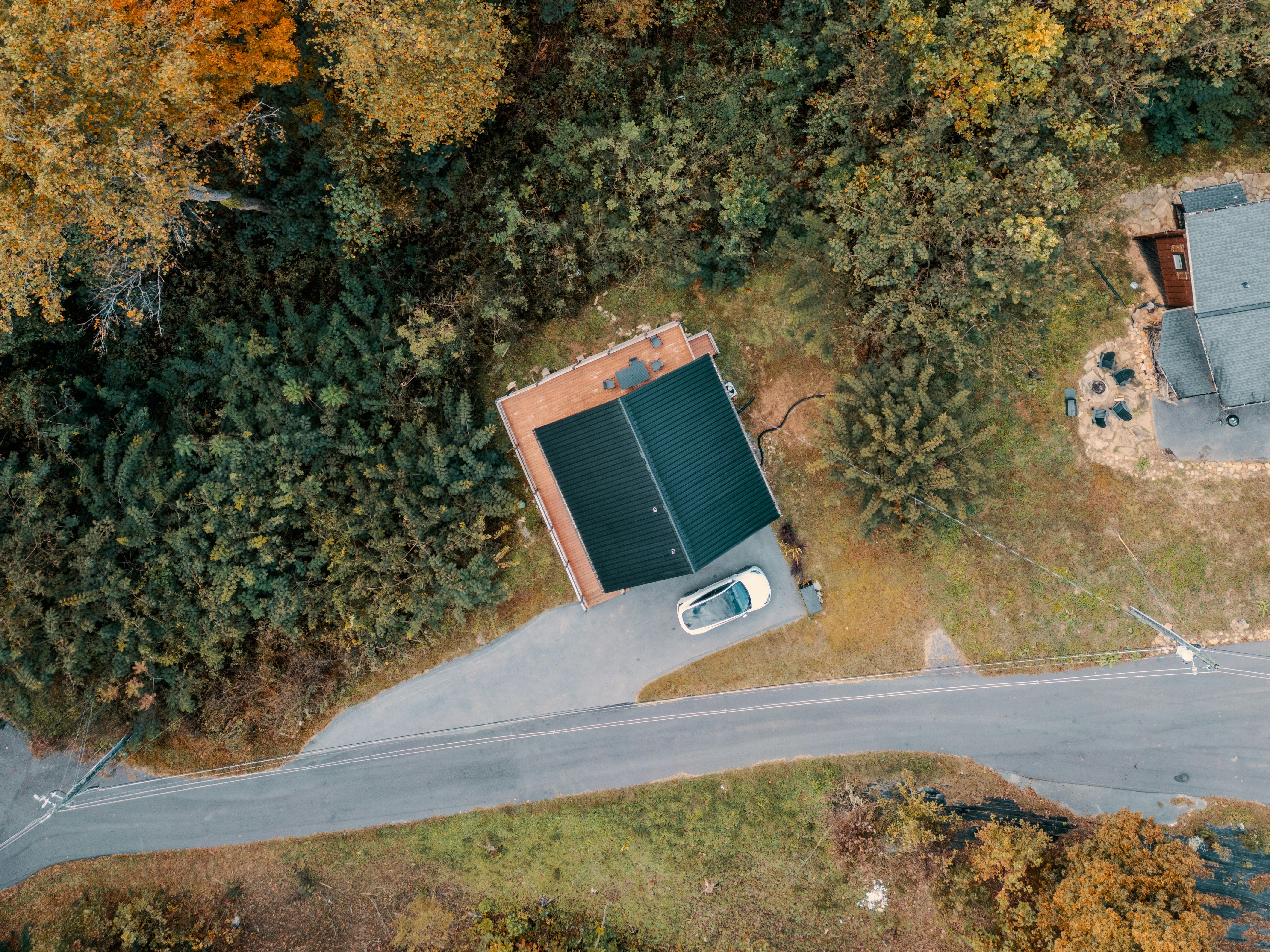 Aerial view of a small cabin surrounded by trees