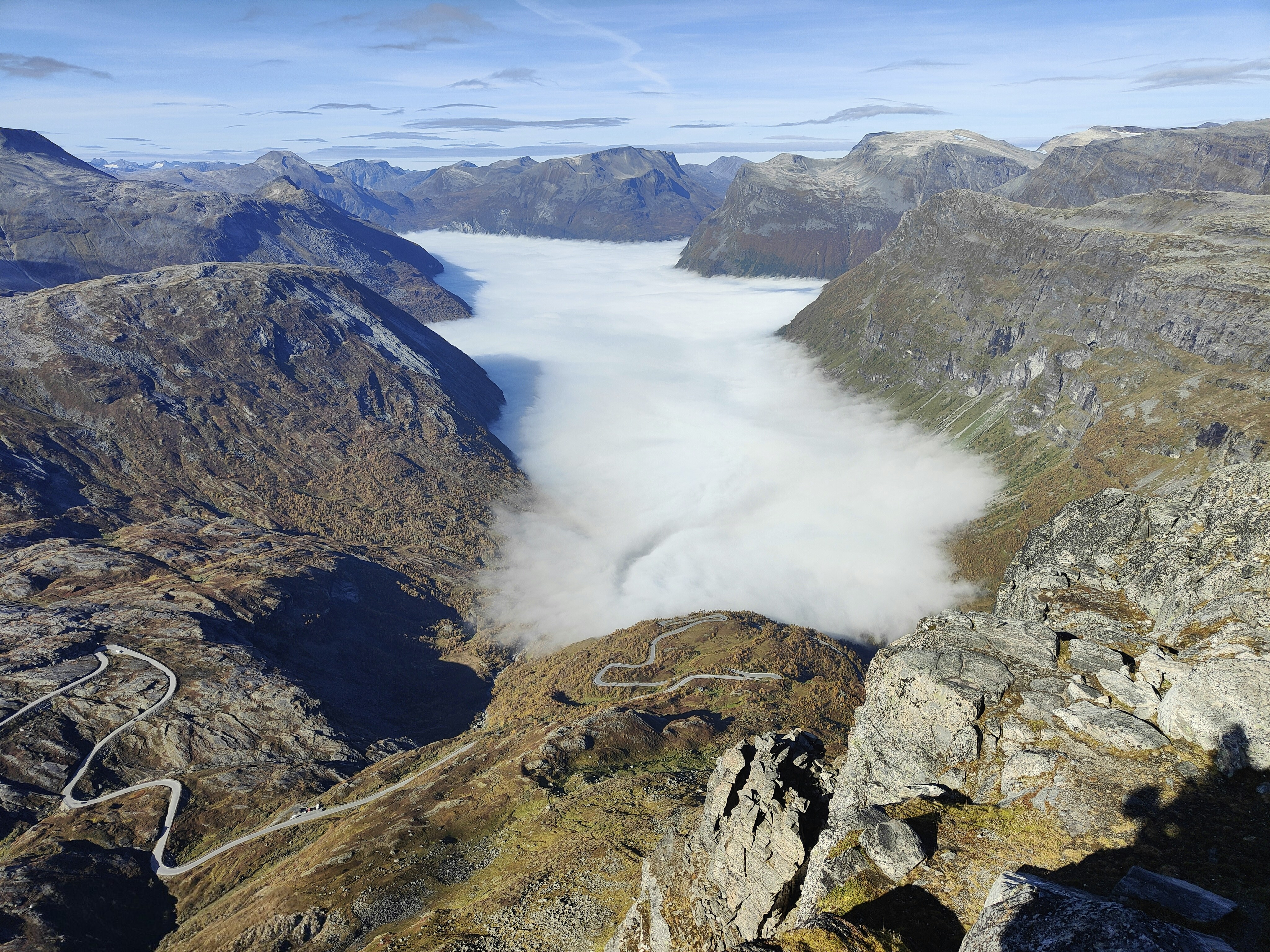 Dalsniba viewpoint, Norway | Fog fills a valley surrounded by mountains.