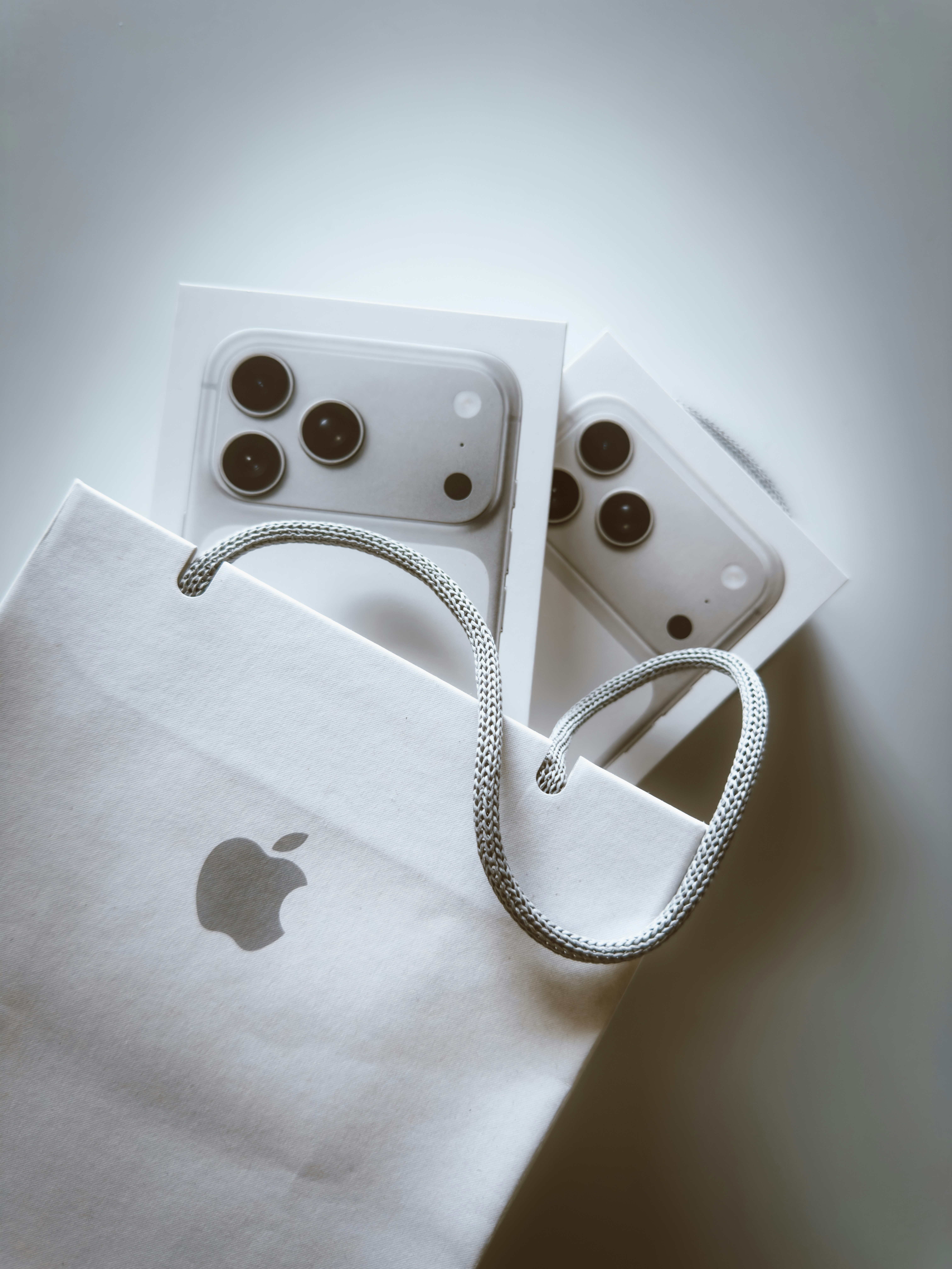 Apple shopping bag with two phone boxes.