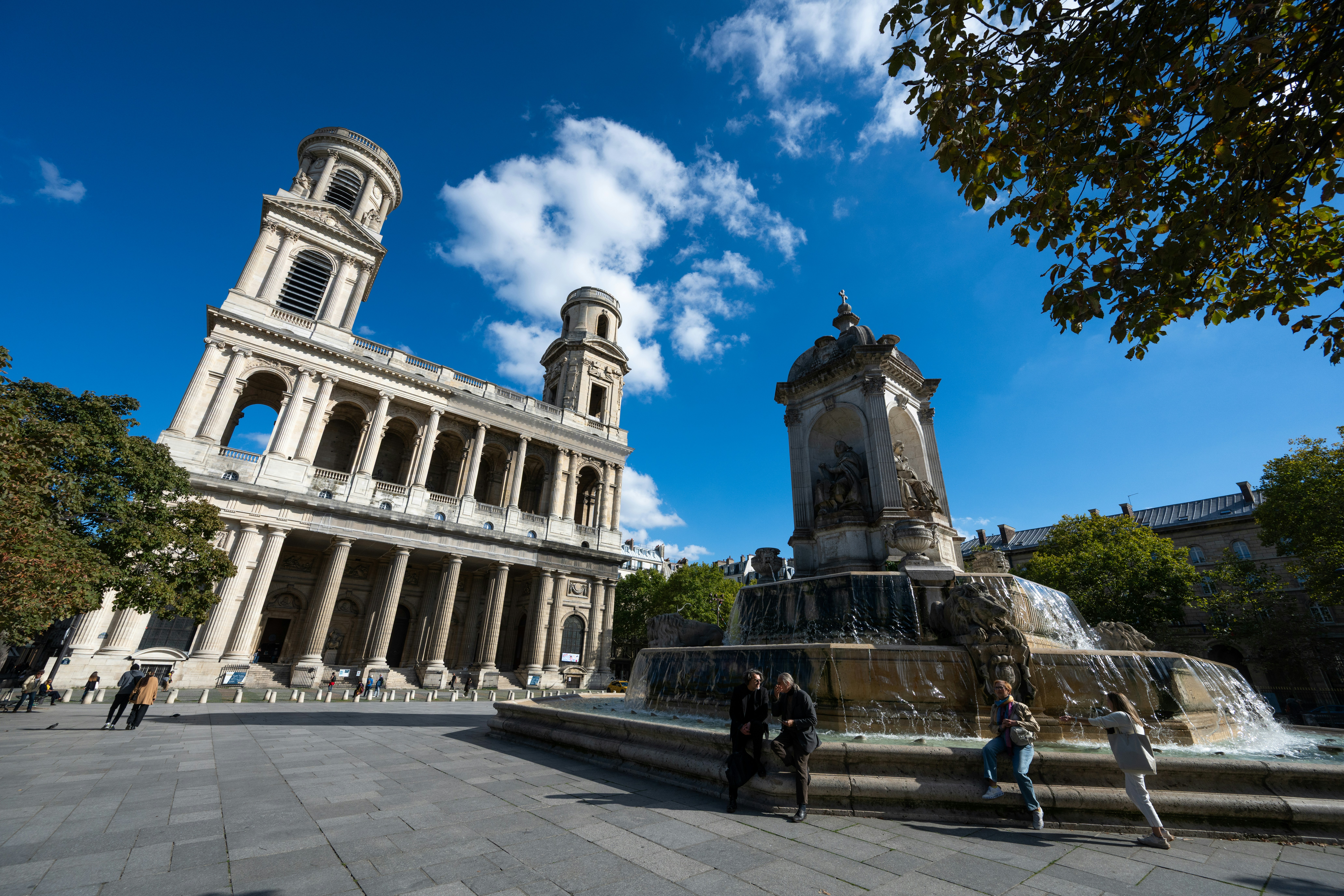 A grand church with a fountain in front
