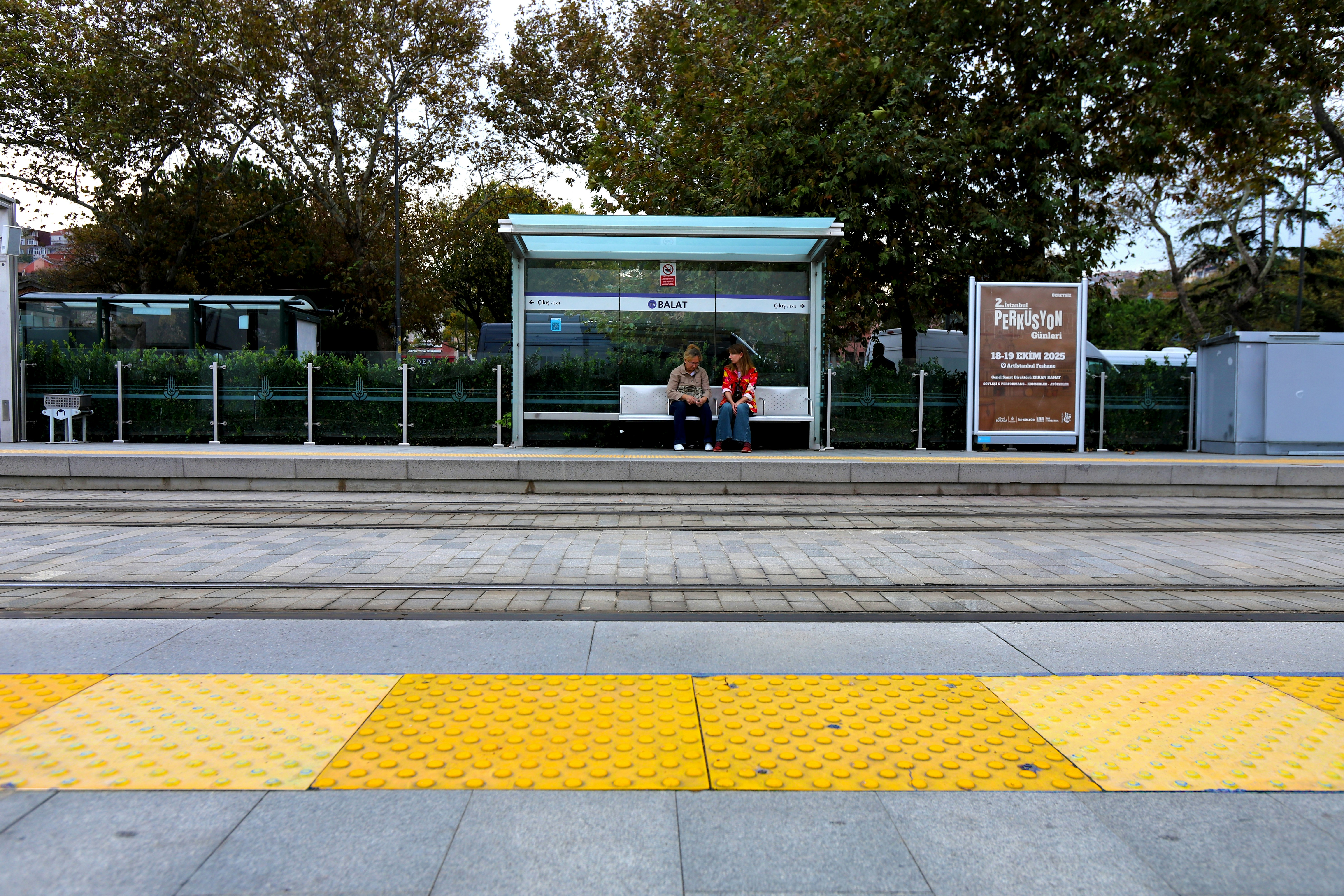 Urban Pause: A Moment at the Tram Stop