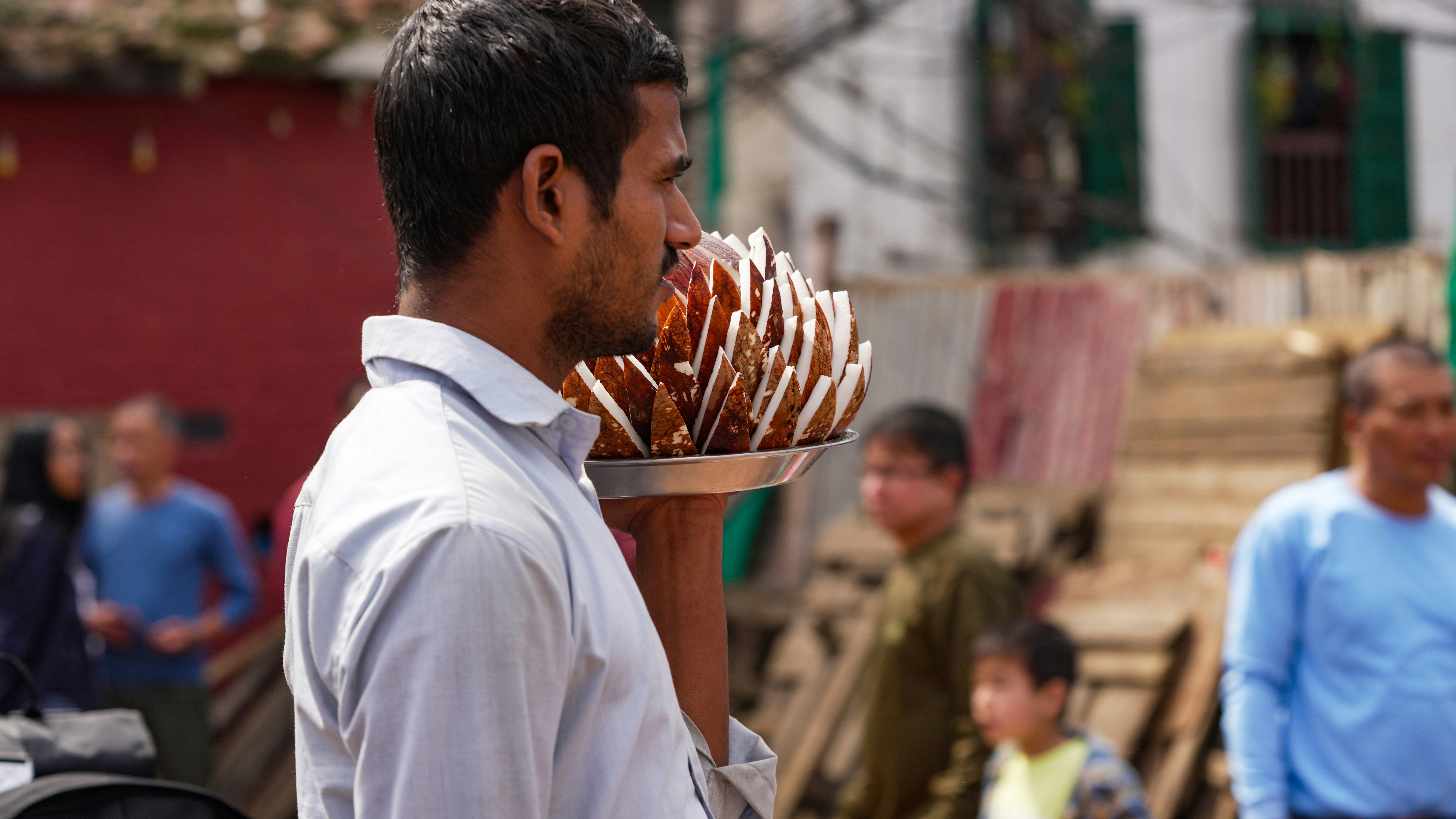 Man carrying a tray of sweets