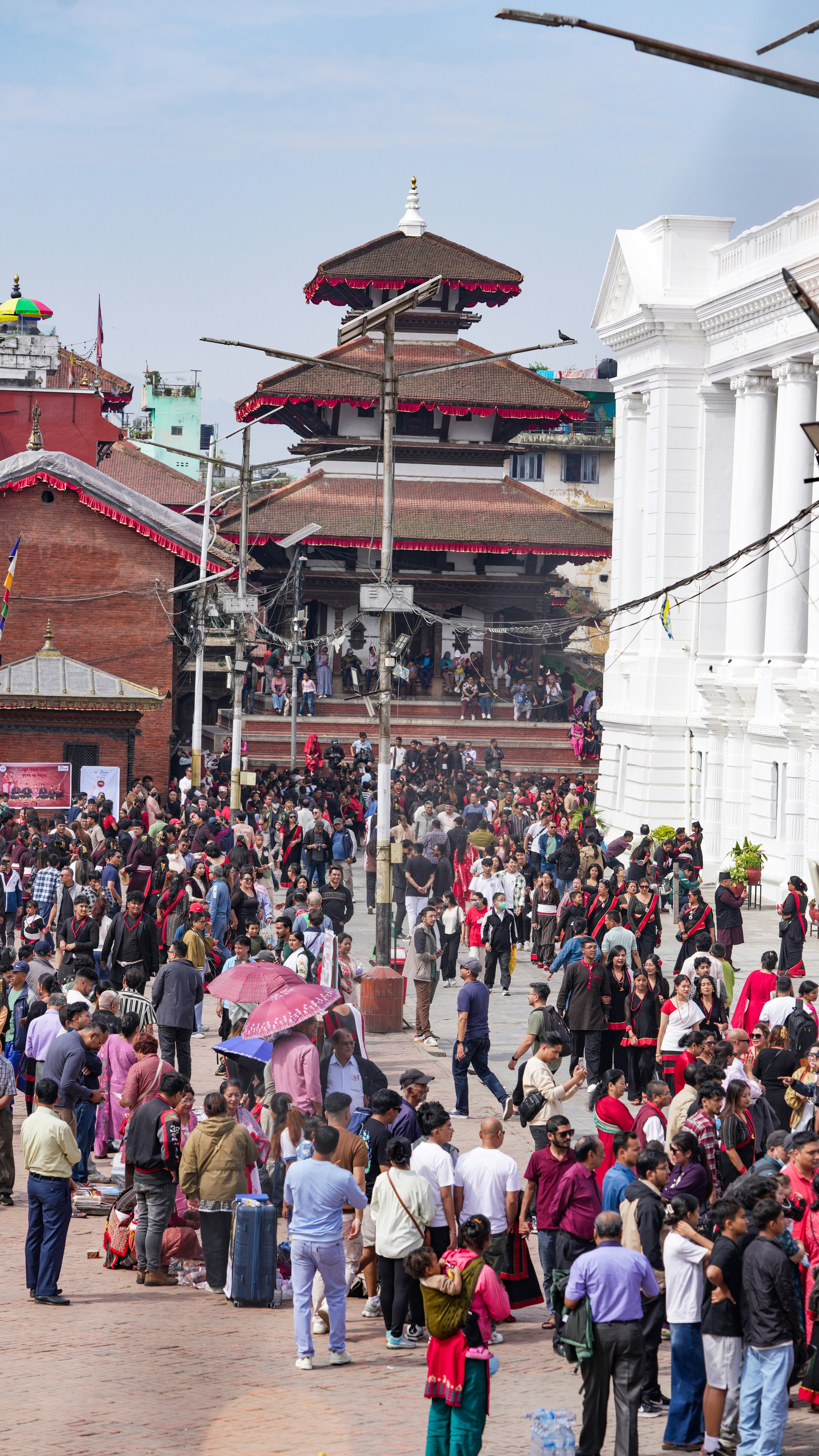 Crowded square in front of a multi-tiered temple