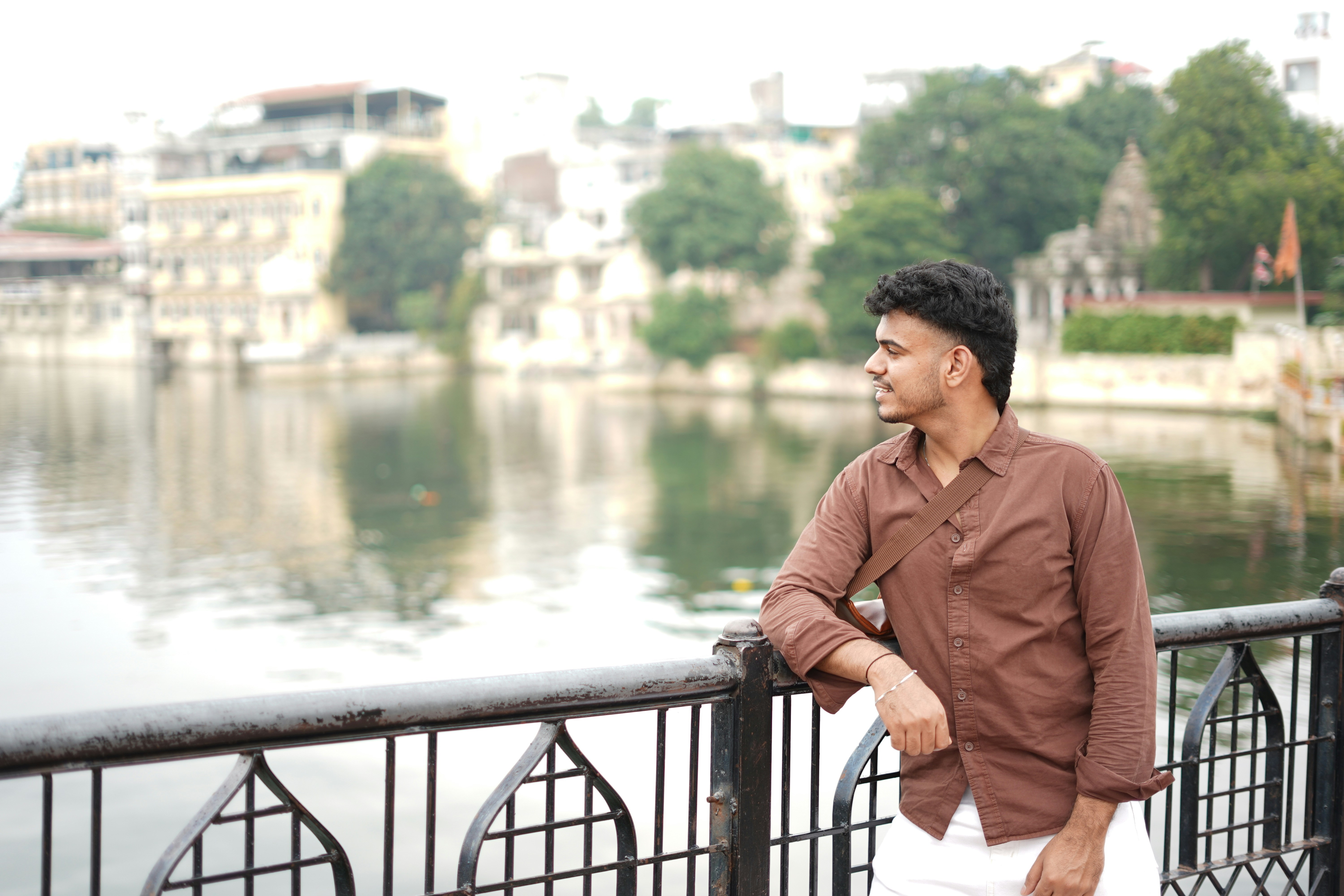 Riverside Gaze: A Quiet Portrait by the City Rail