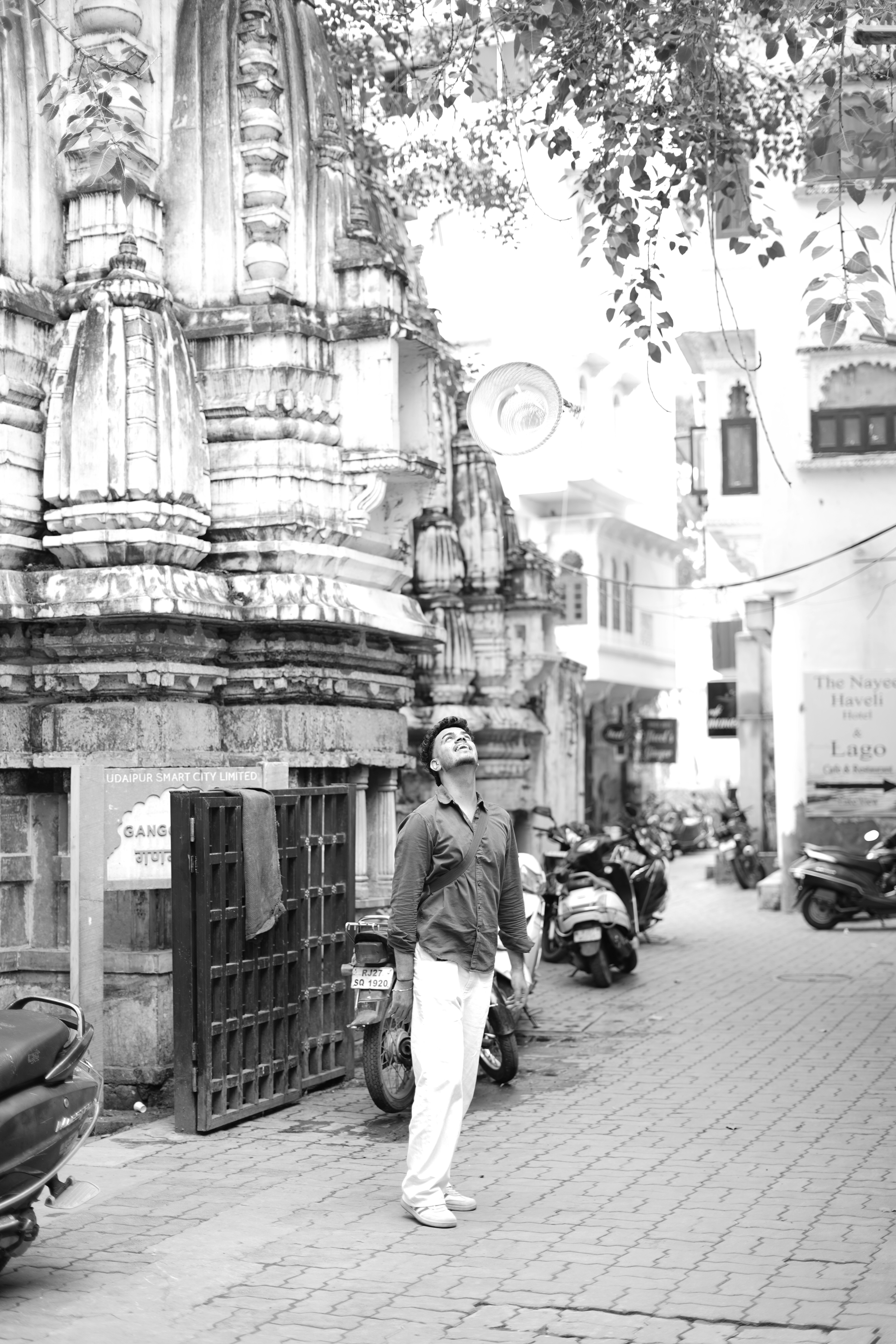 Gaze Toward the Carved Spires: A Quiet Street Portrait in Mono