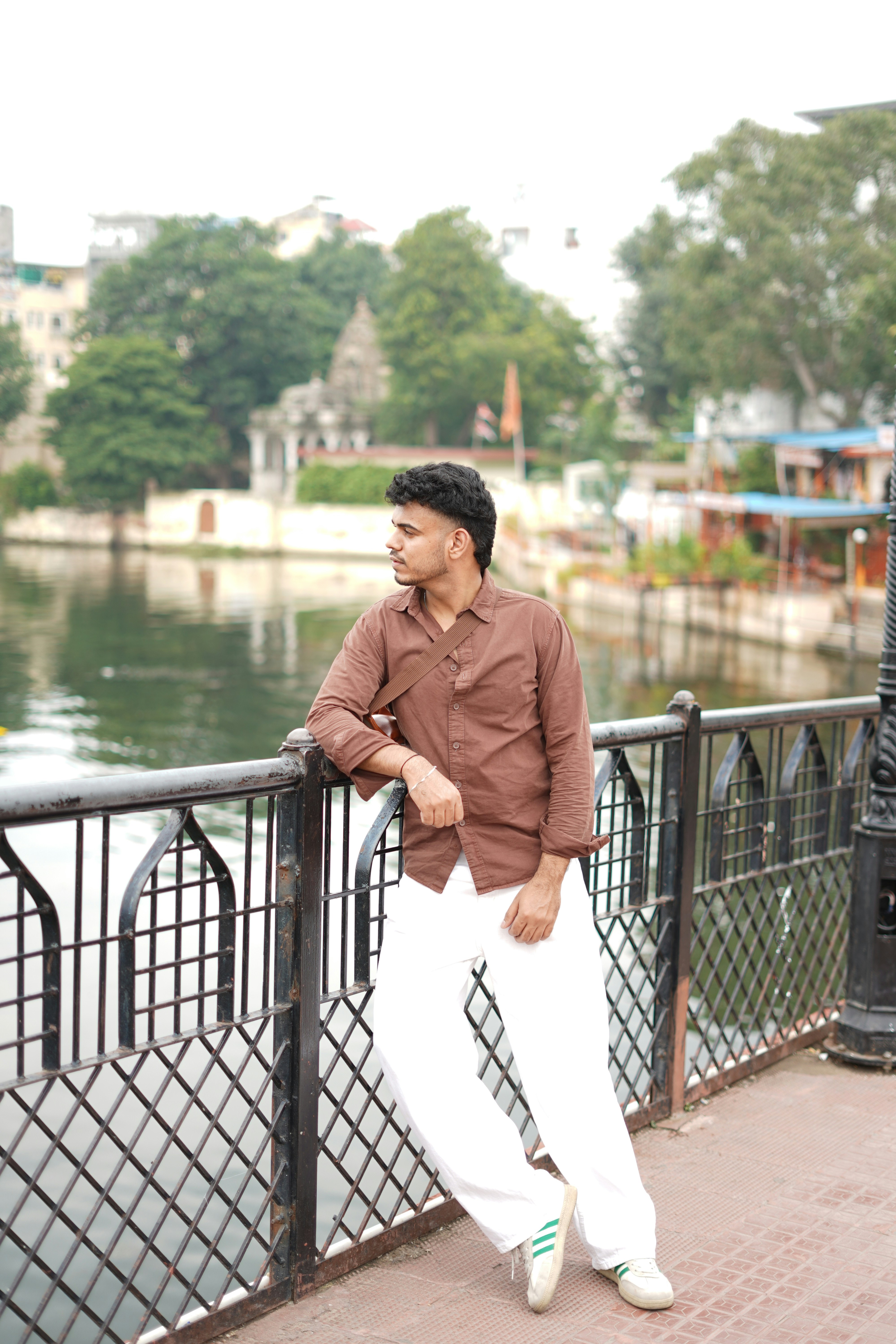 Riverside Quiet: A Man in Brown by the Rail