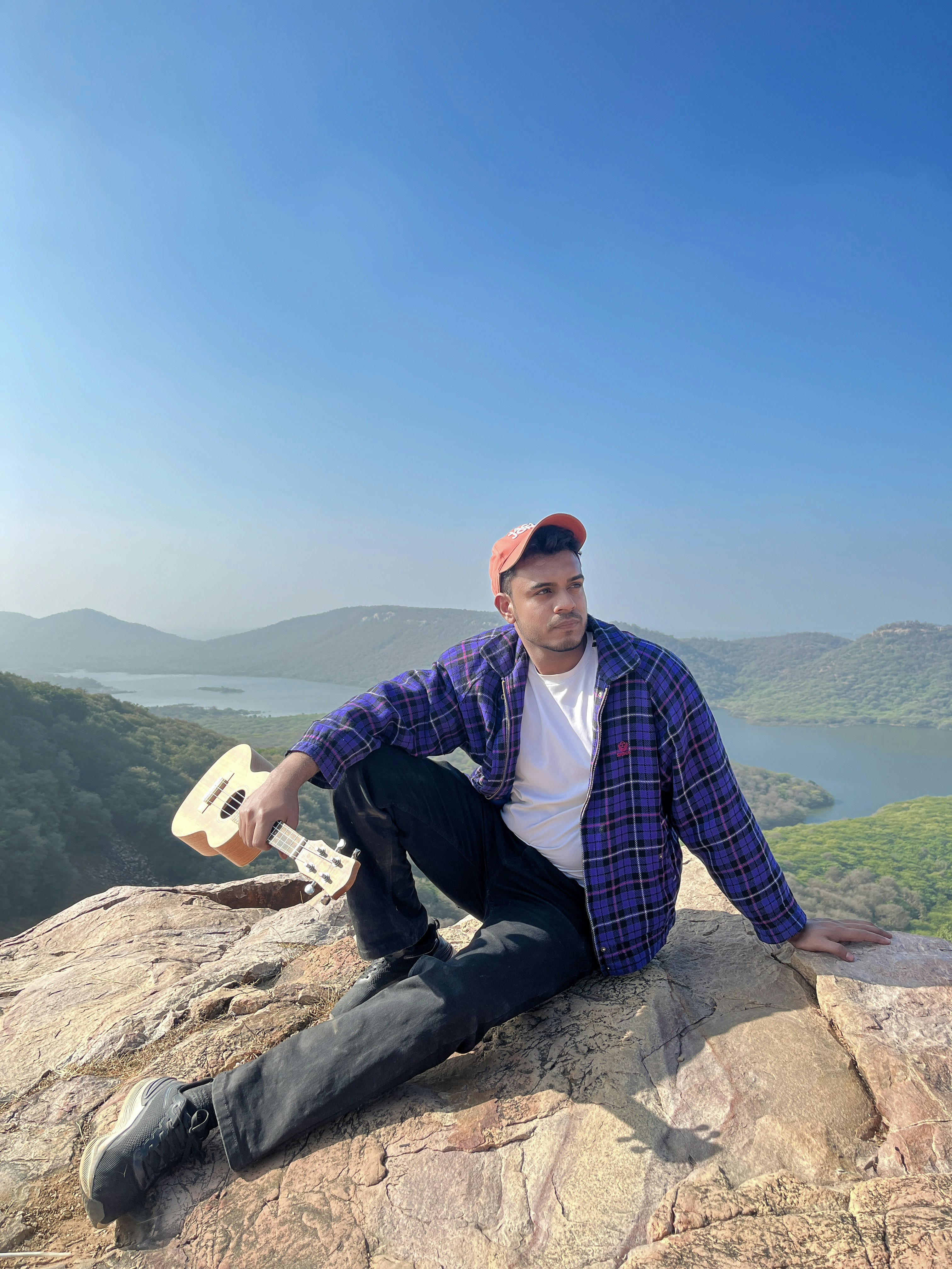 Rocky vista and guitar on a sunlit cliff