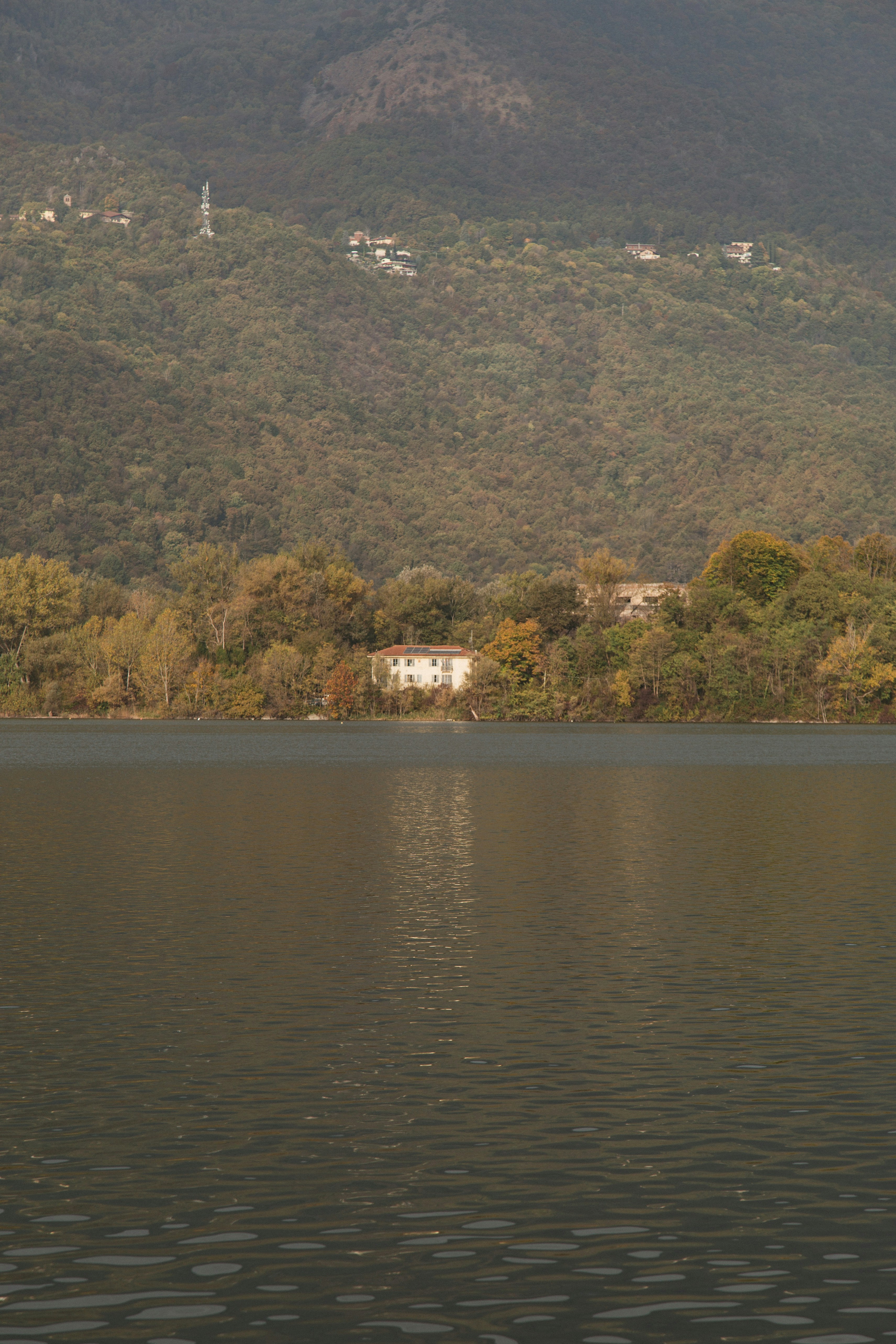 Hello =) Follow my journey on insta: I_am_simoesse | White building on a tree-lined shore by a lake.