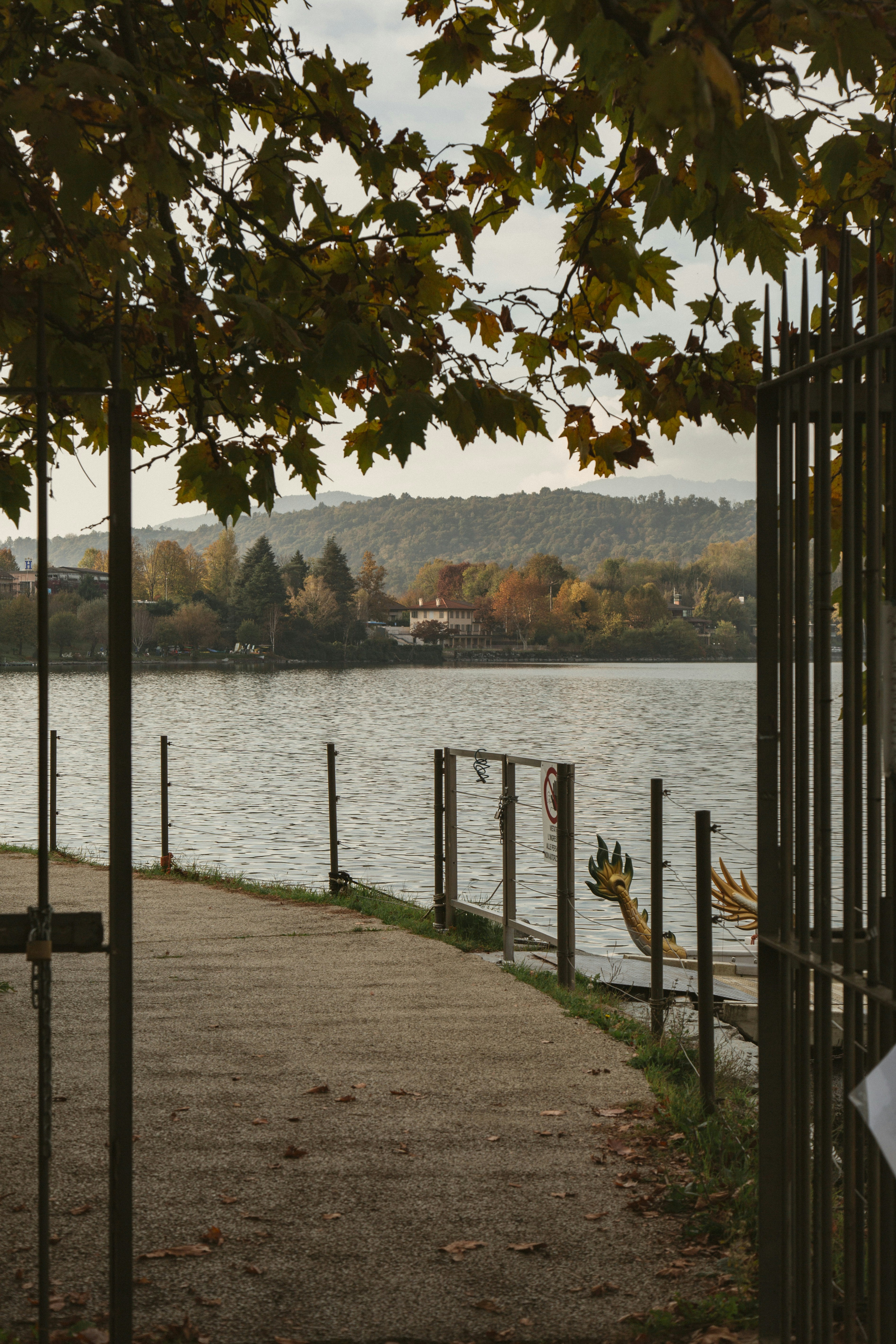 Hello =) Follow my journey on insta: I_am_simoesse | Path along a lake with autumn trees and distant hills.