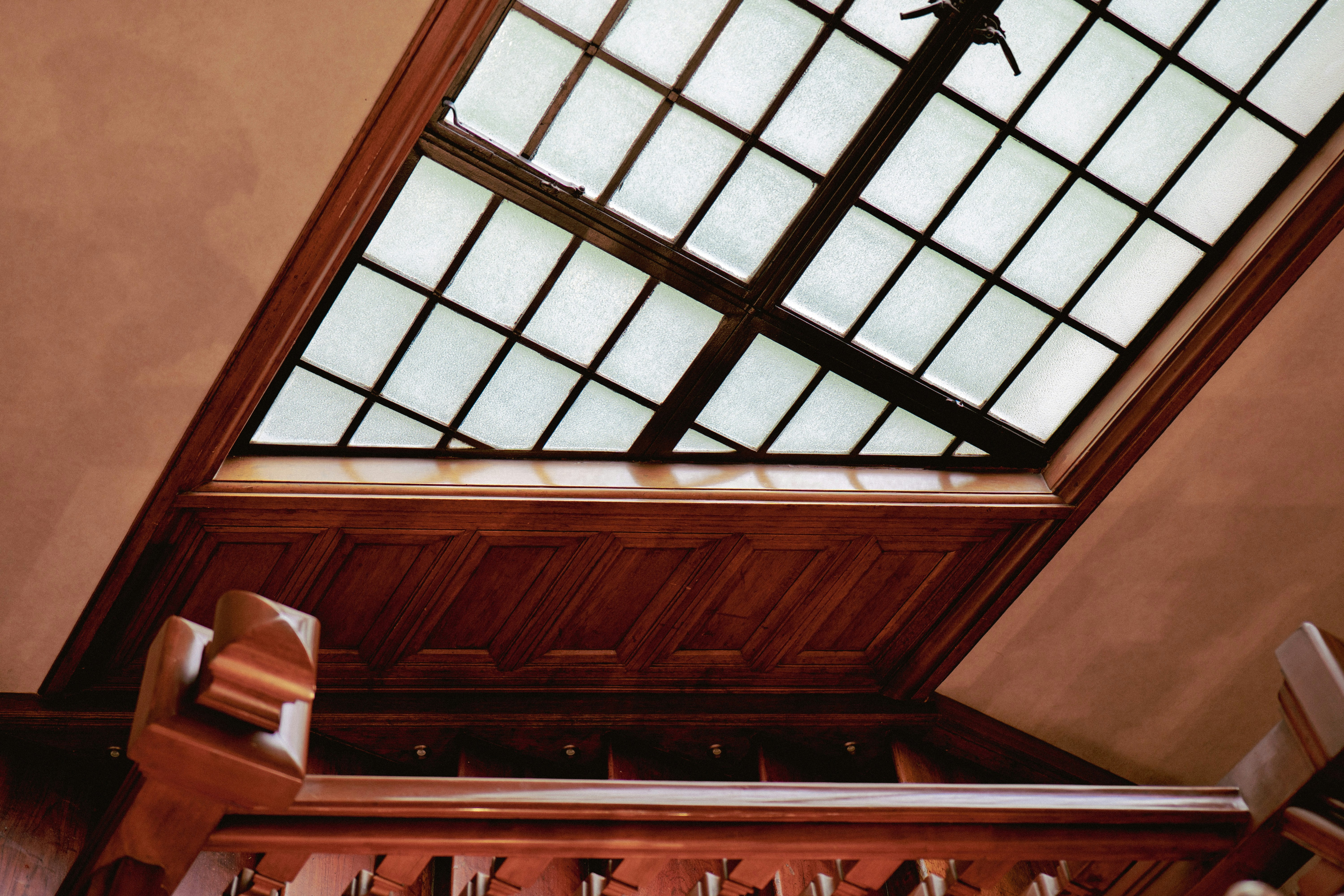 Wooden staircase with a skylight above