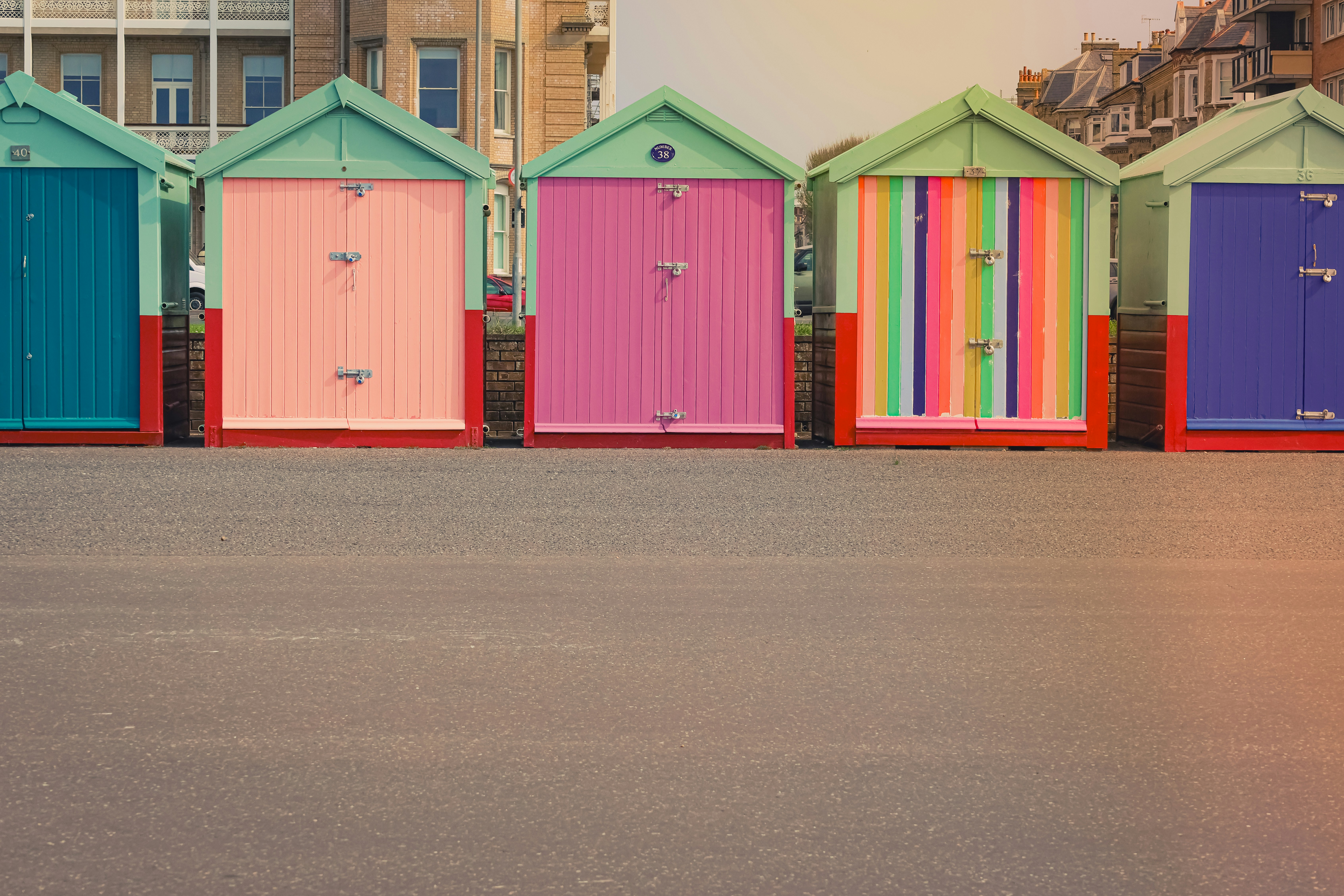 Beach huts on brighton seafront | Colorful beach huts in a row