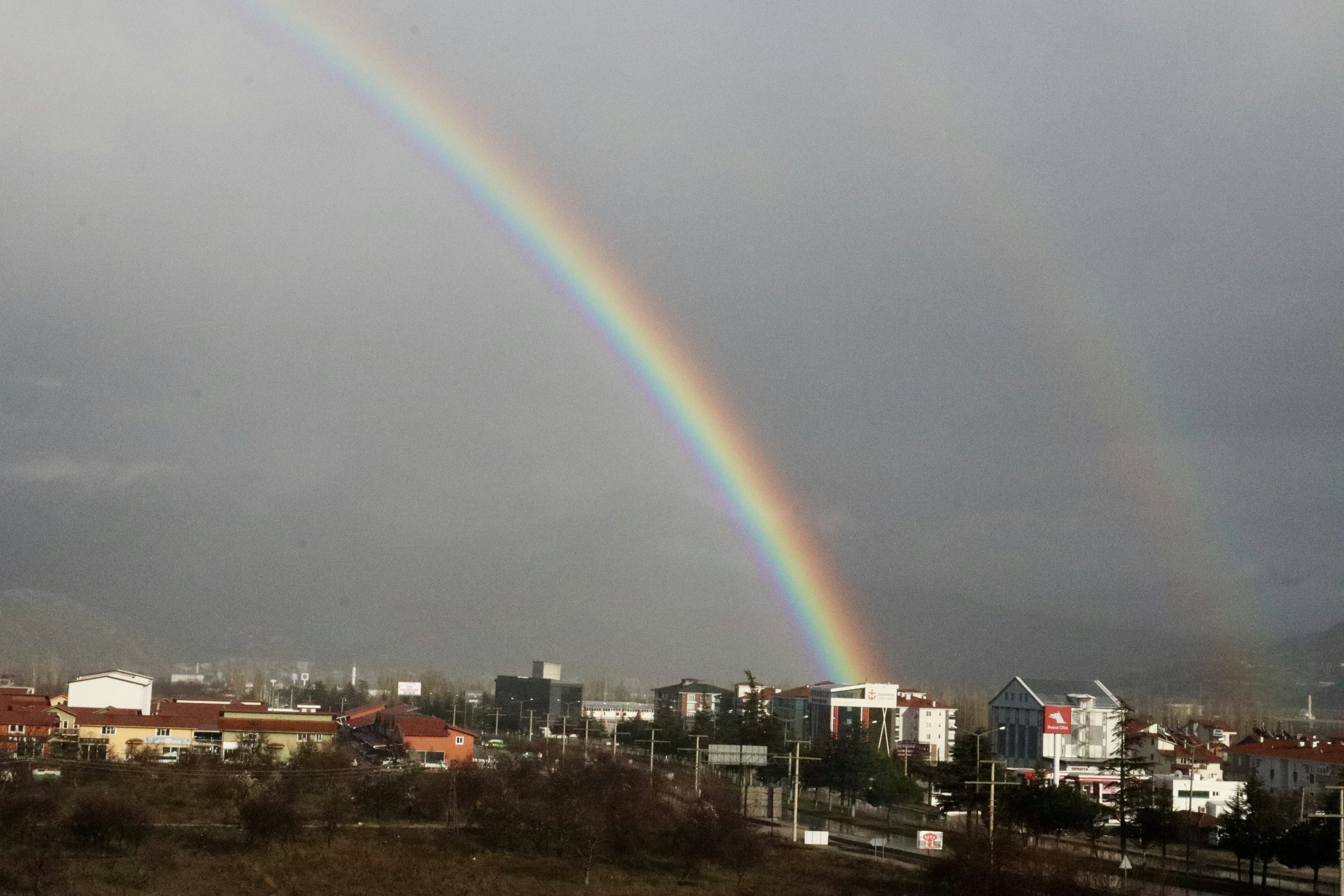Arc of Colors Over Urban Landscape