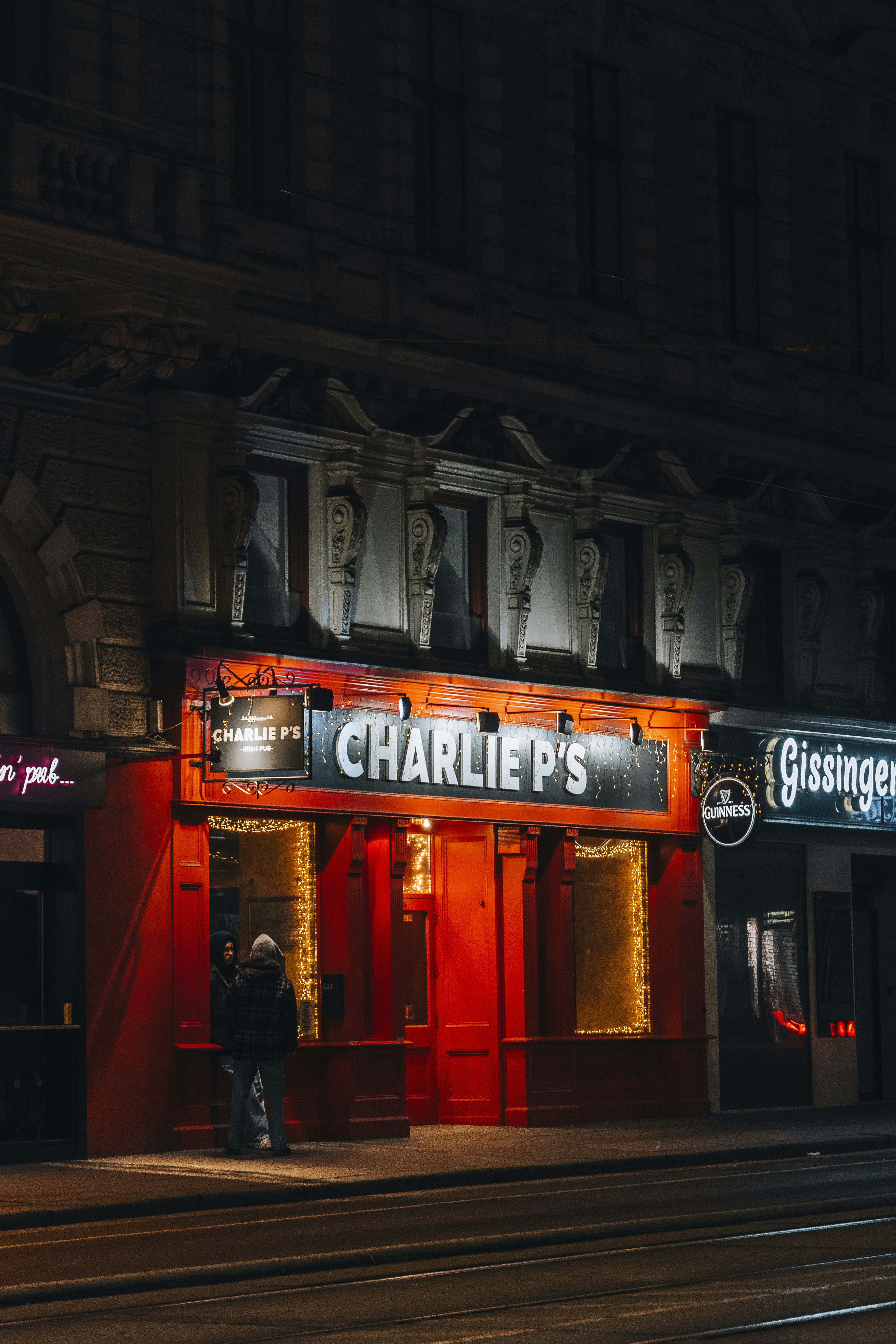 Charlie p's bar facade at night with streetlights.