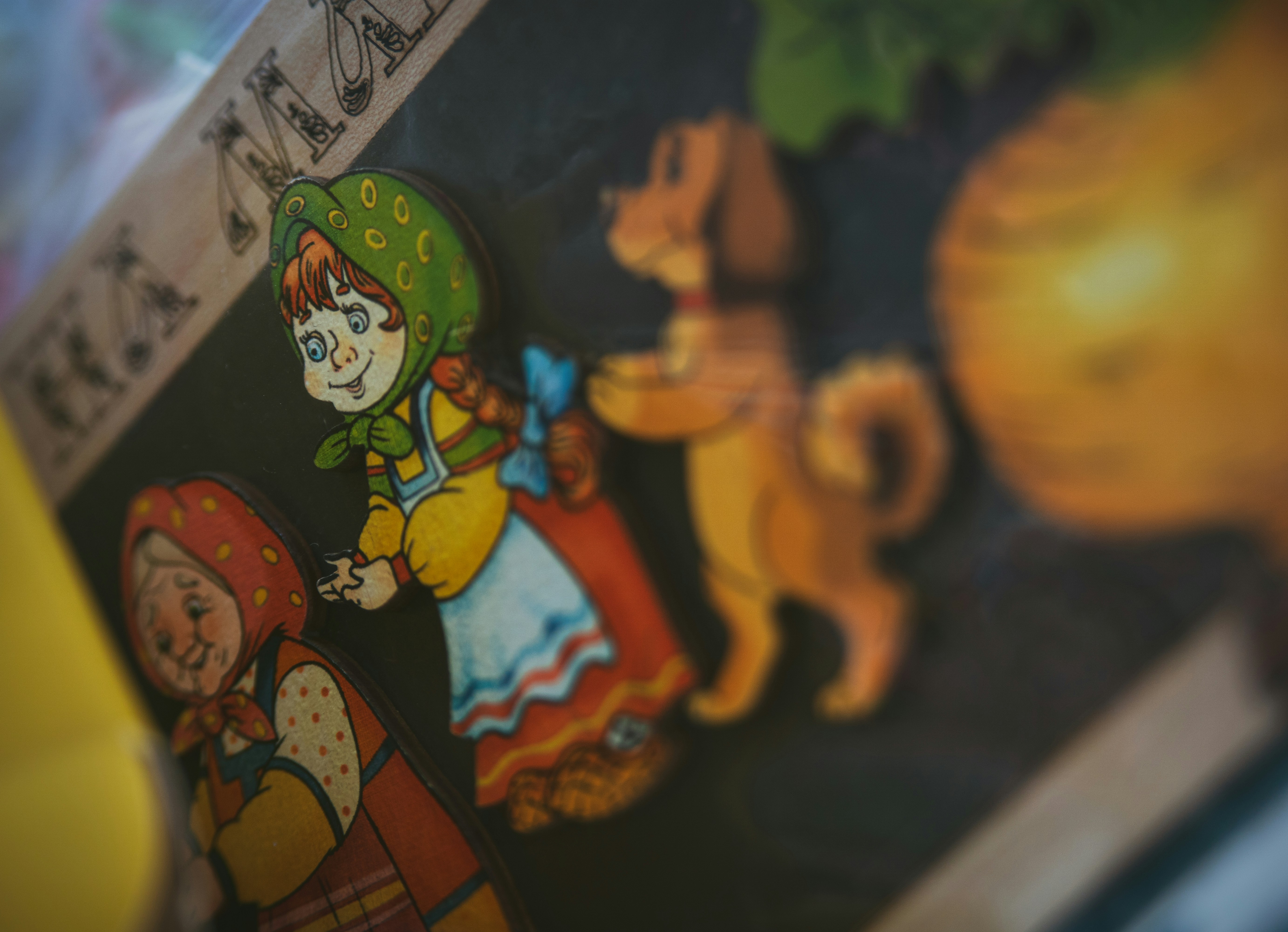 A children’s toy based on a famous Russian fairy tale. | Children's storybook characters with a dog and onion.