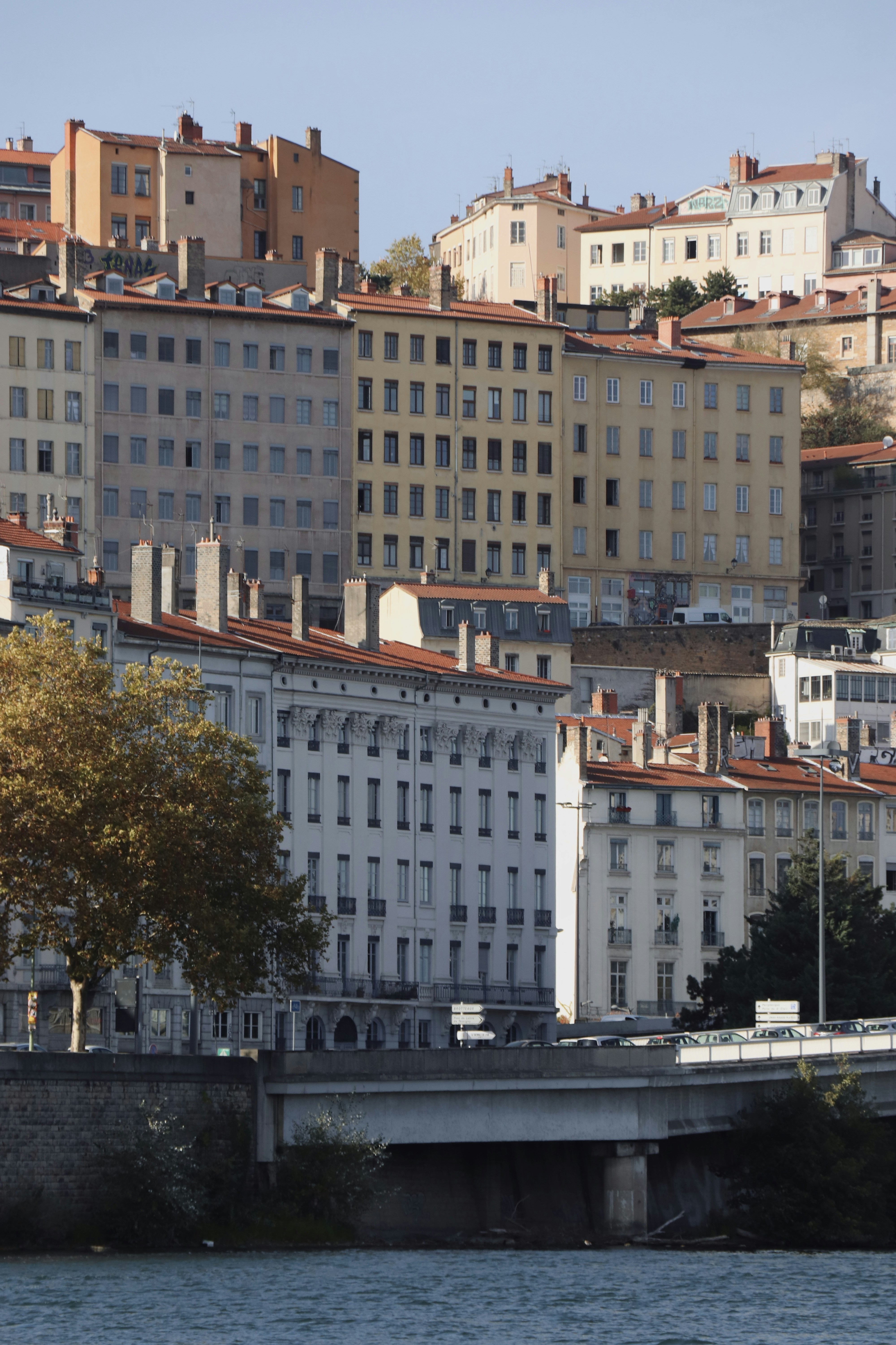 Pastel Staircase by the River: Riverside Blocks Rising Above the Bridge