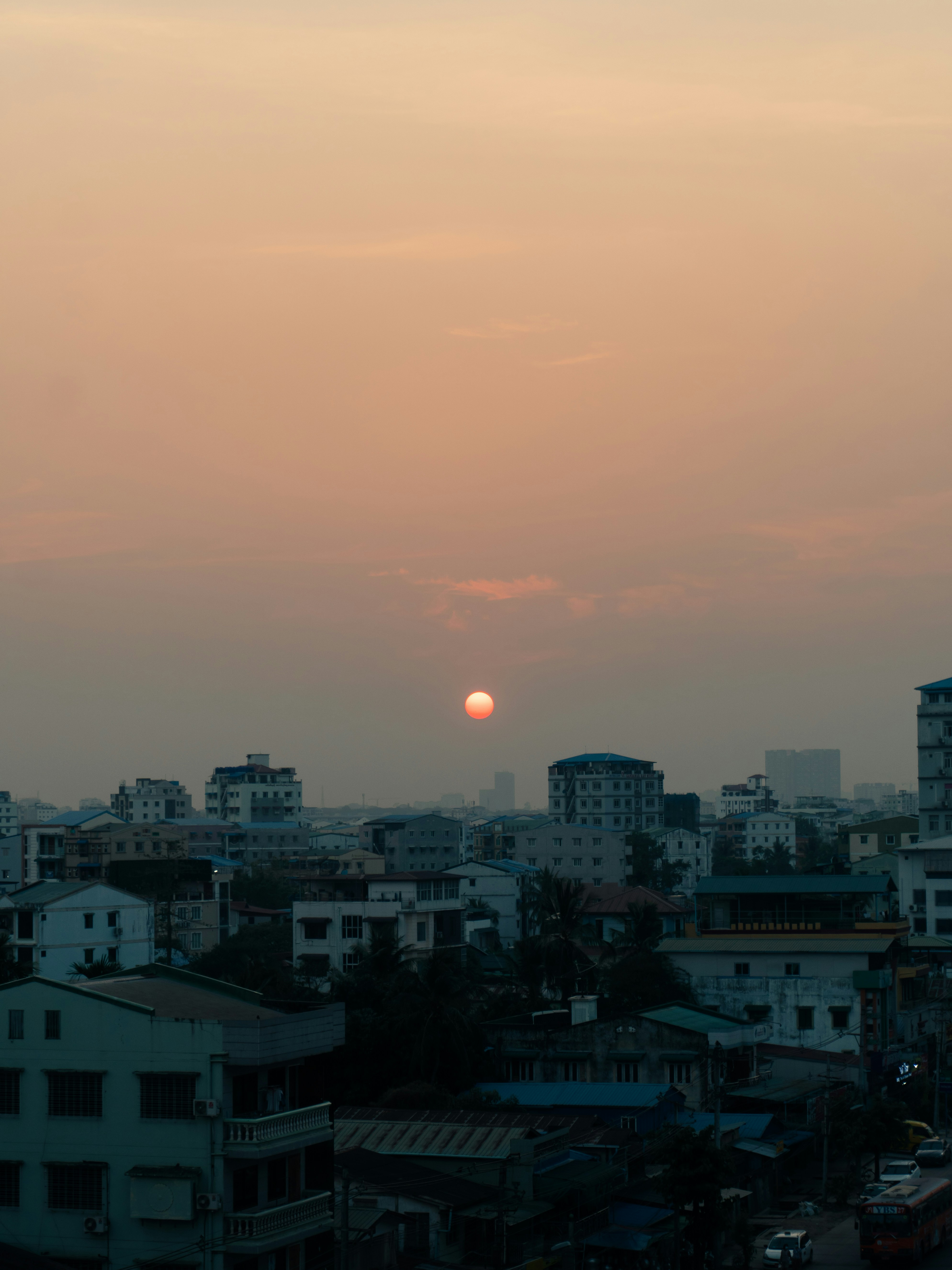 City skyline at sunset with hazy sky