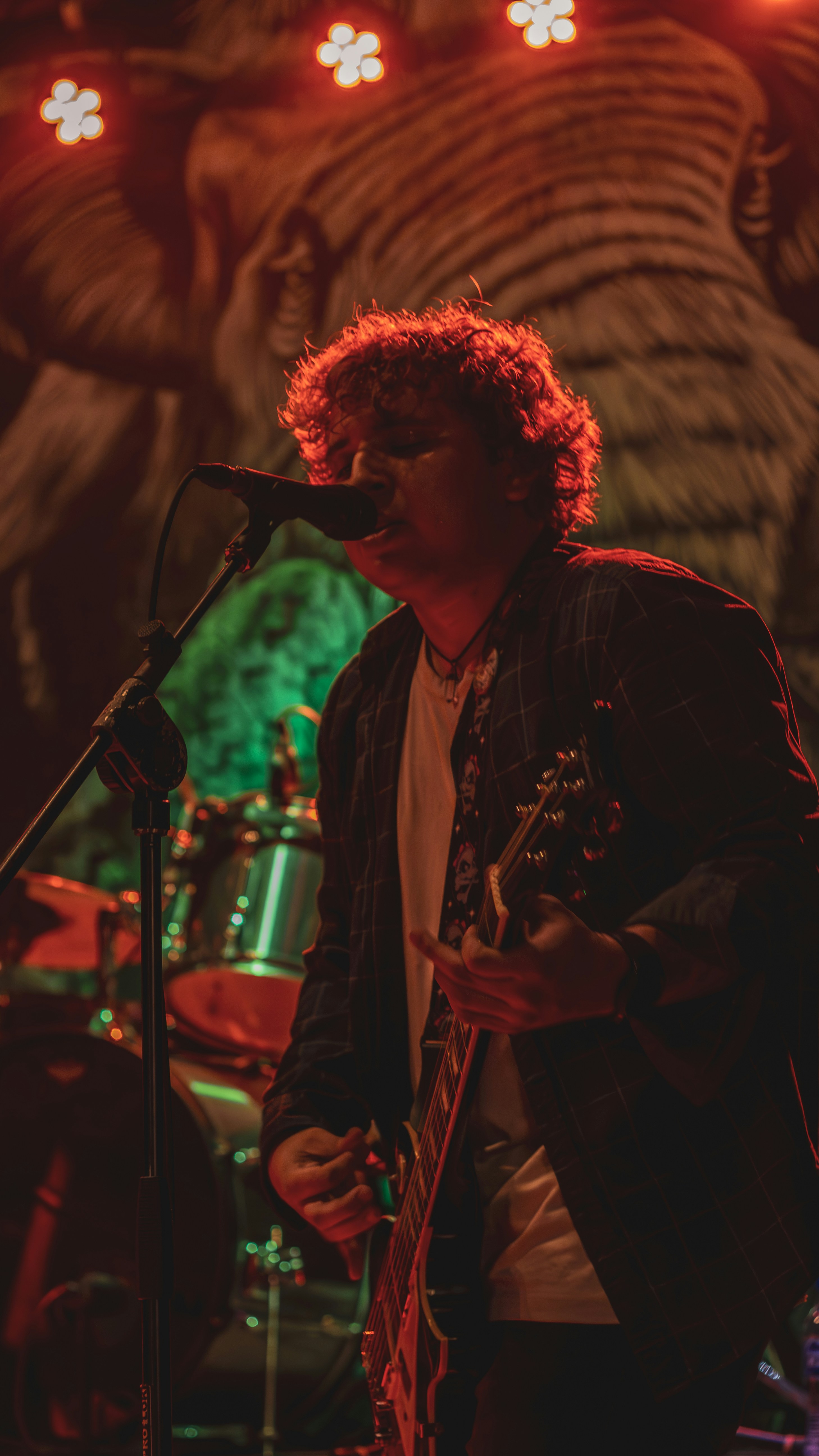 Crimson Spotlight: A guitarist leads a late-night riff