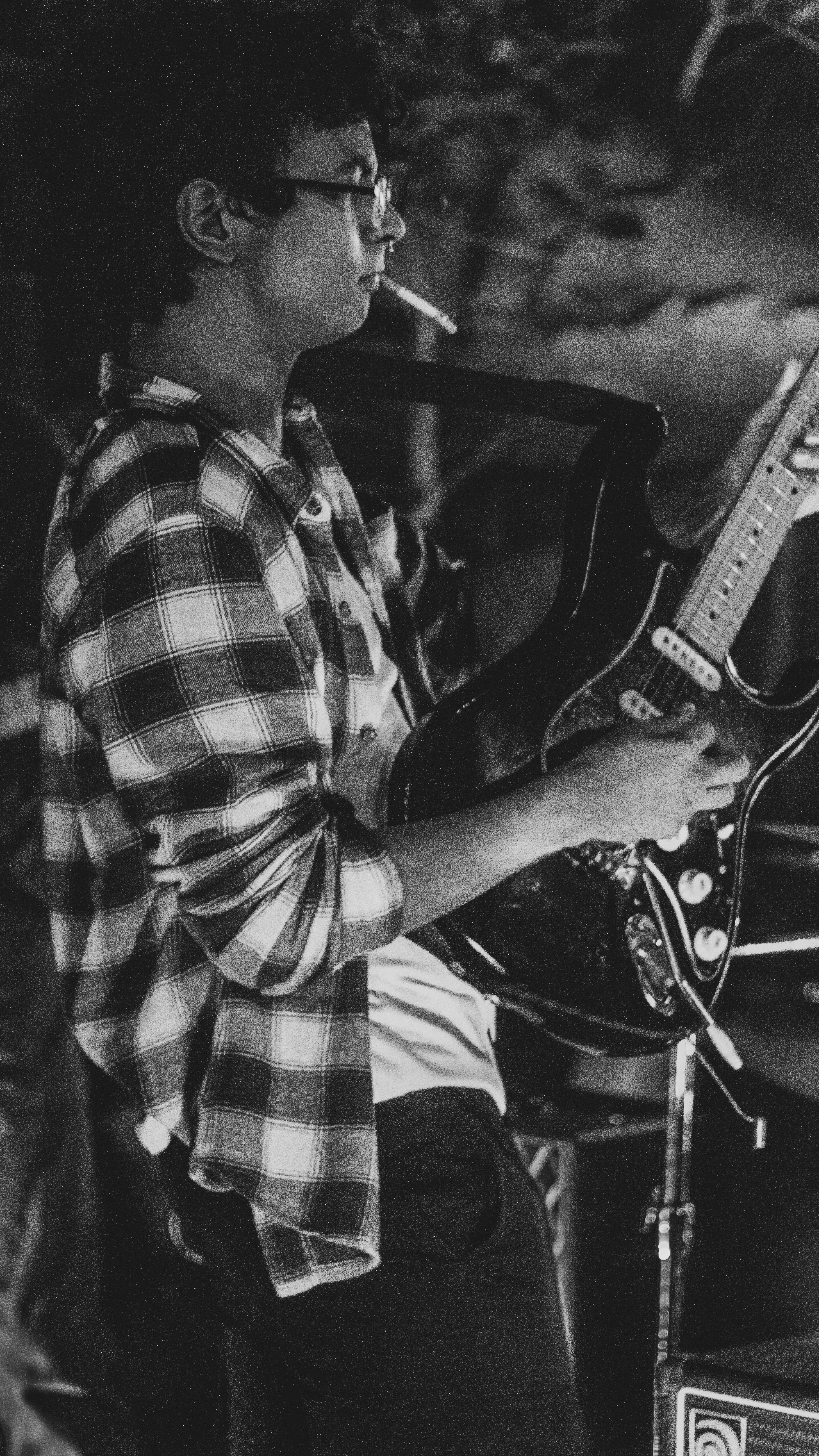 Shadows and Six Strings: A Gritty Portrait of a Nightstage Guitarist