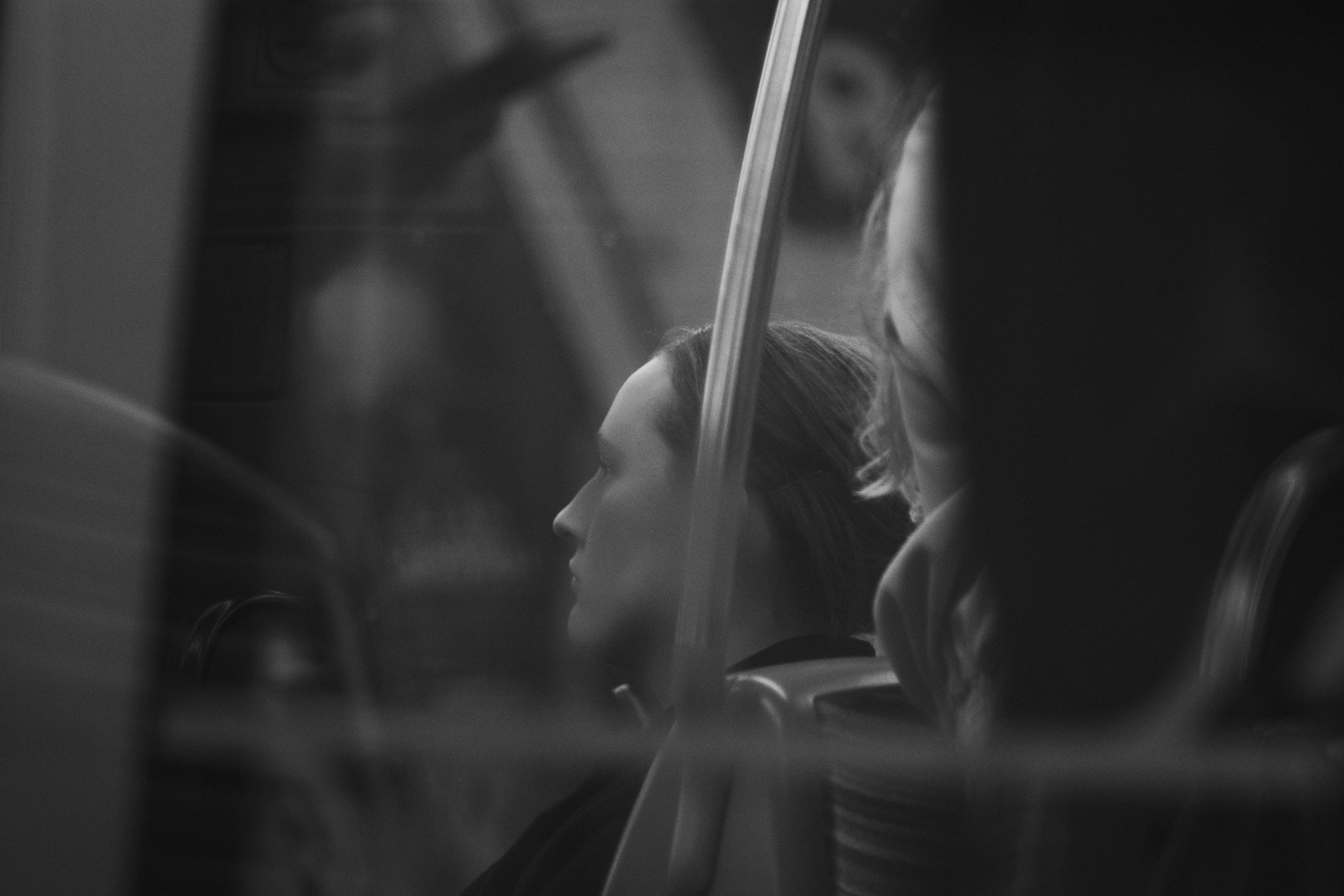Reflections of Commuters: A Moment in Transit