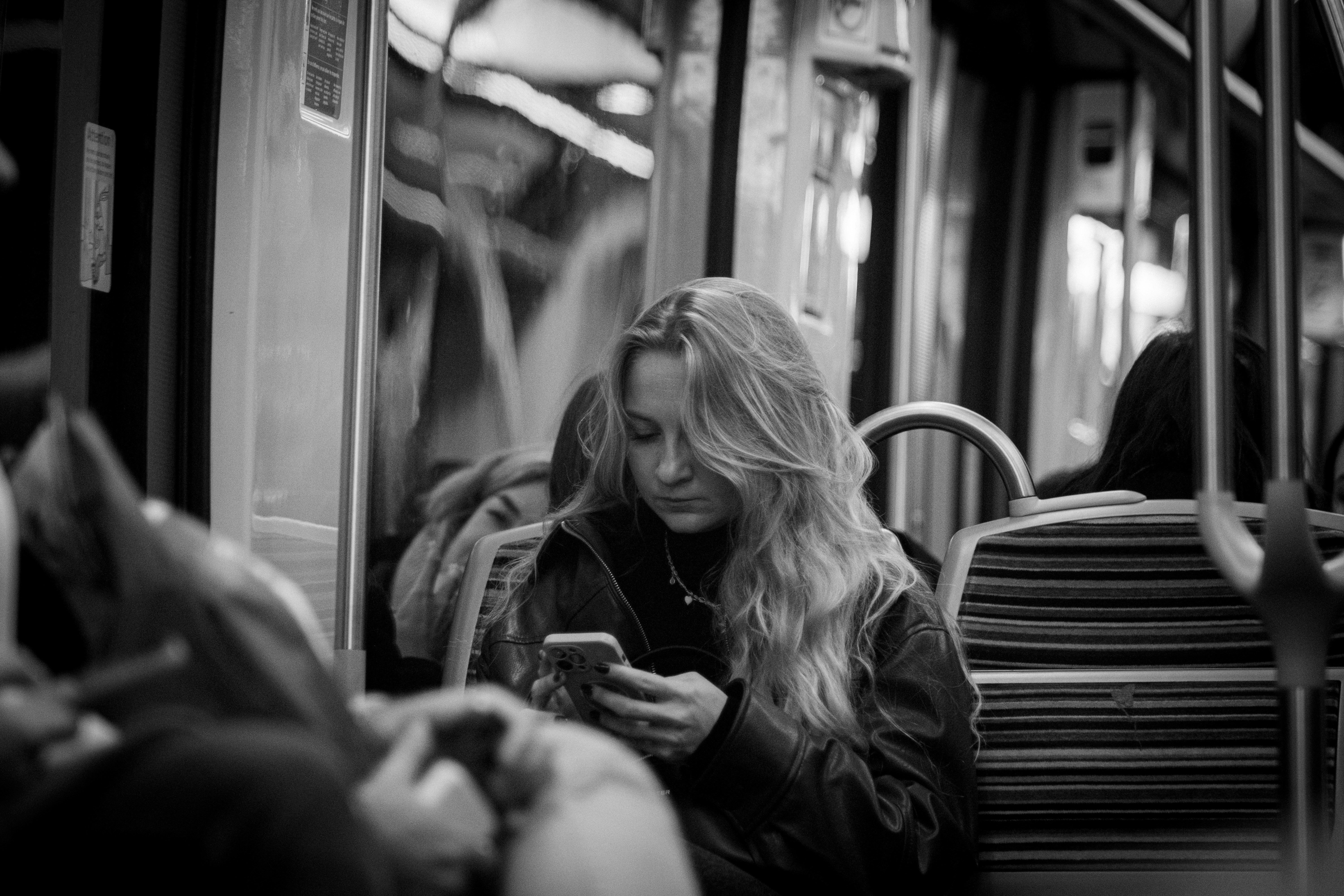 Woman looking at her phone on a bus