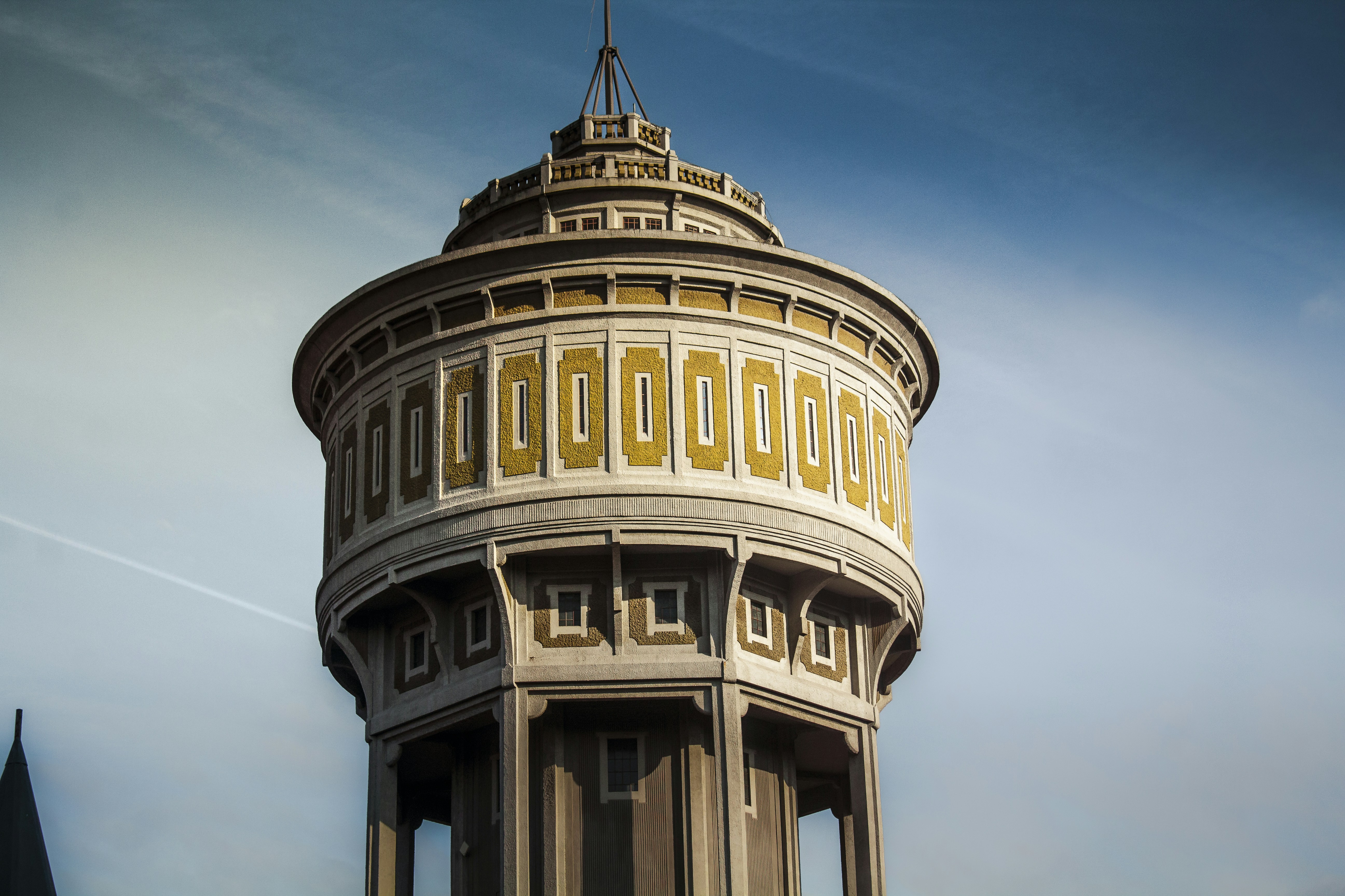 Ornate water tower against a clear blue sky.