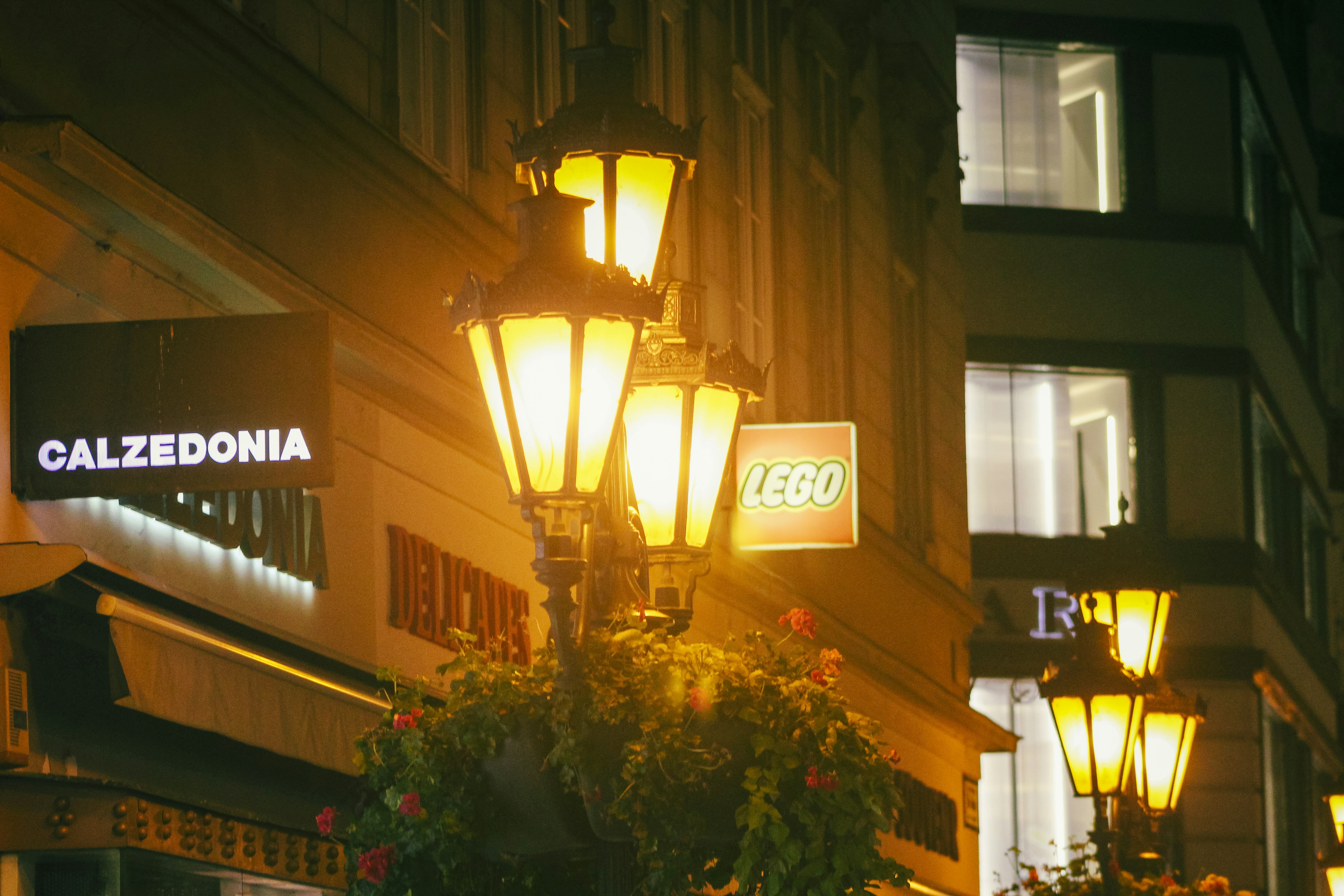 Street lamps illuminate shops at night