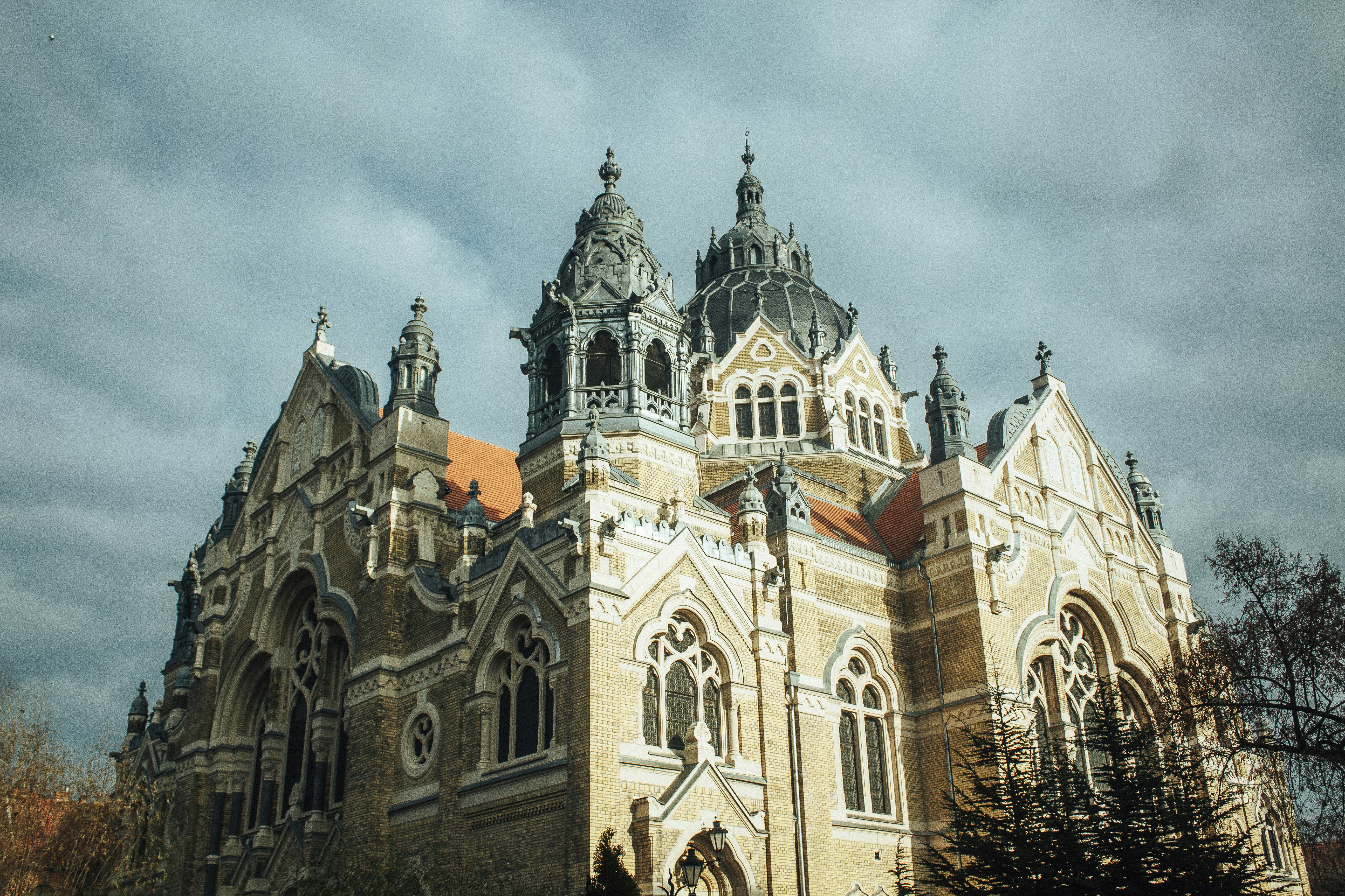 Elaborate church architecture under a cloudy sky