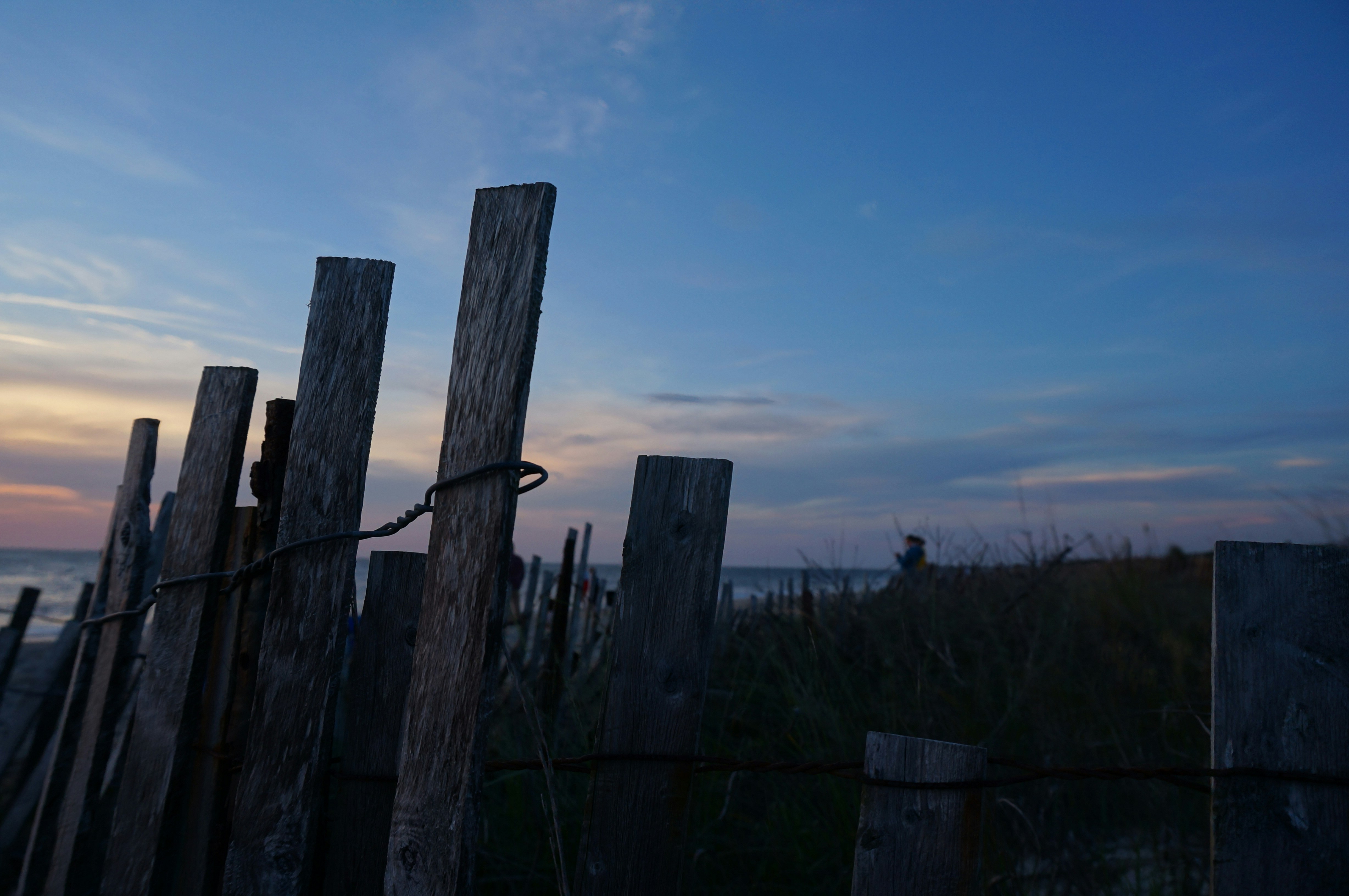 Whispers of the Dusk: A Wooden Barrier's Solitude