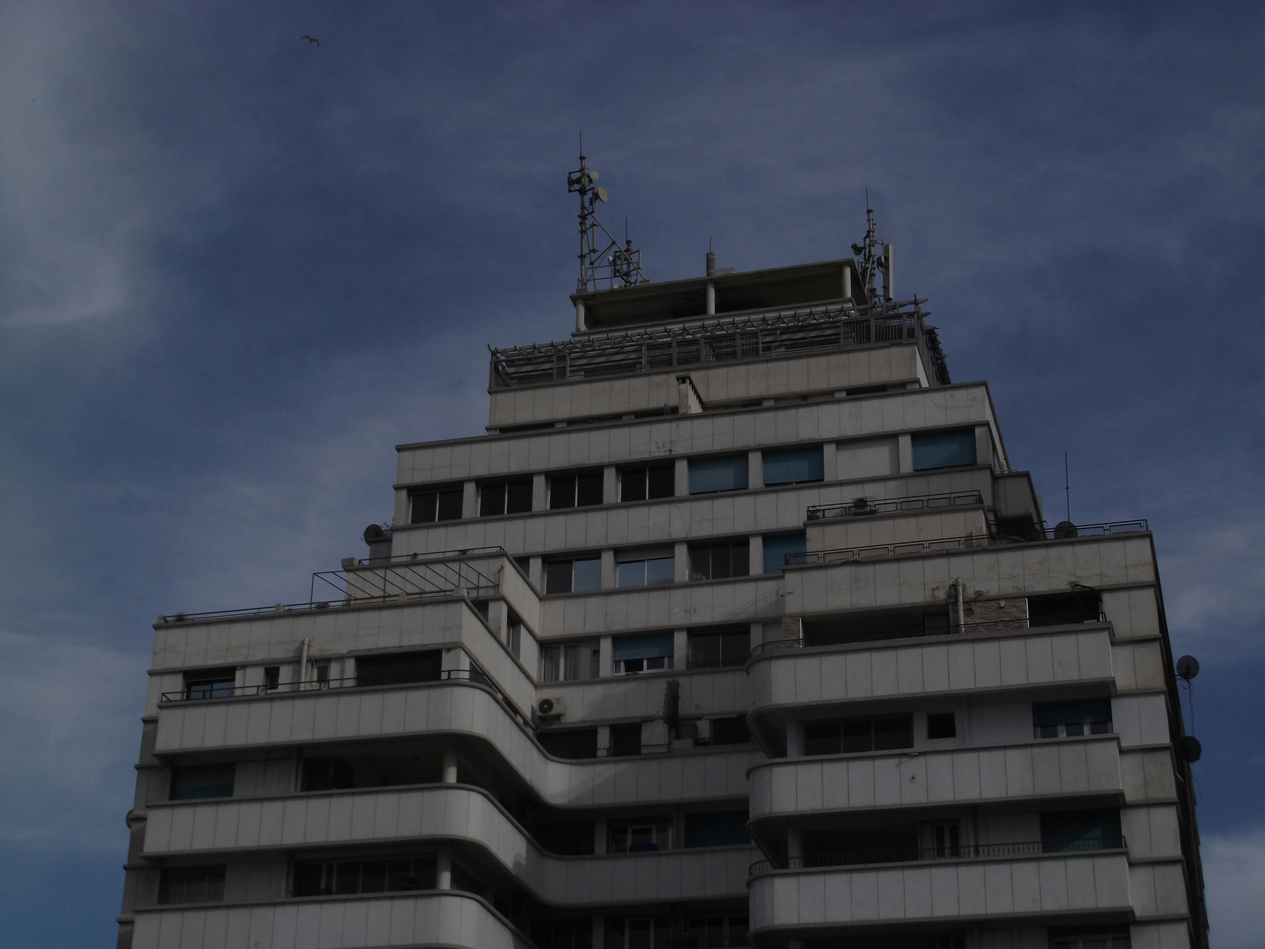 Terraced Skyline: A stepped concrete tower reaching toward a cobalt sky