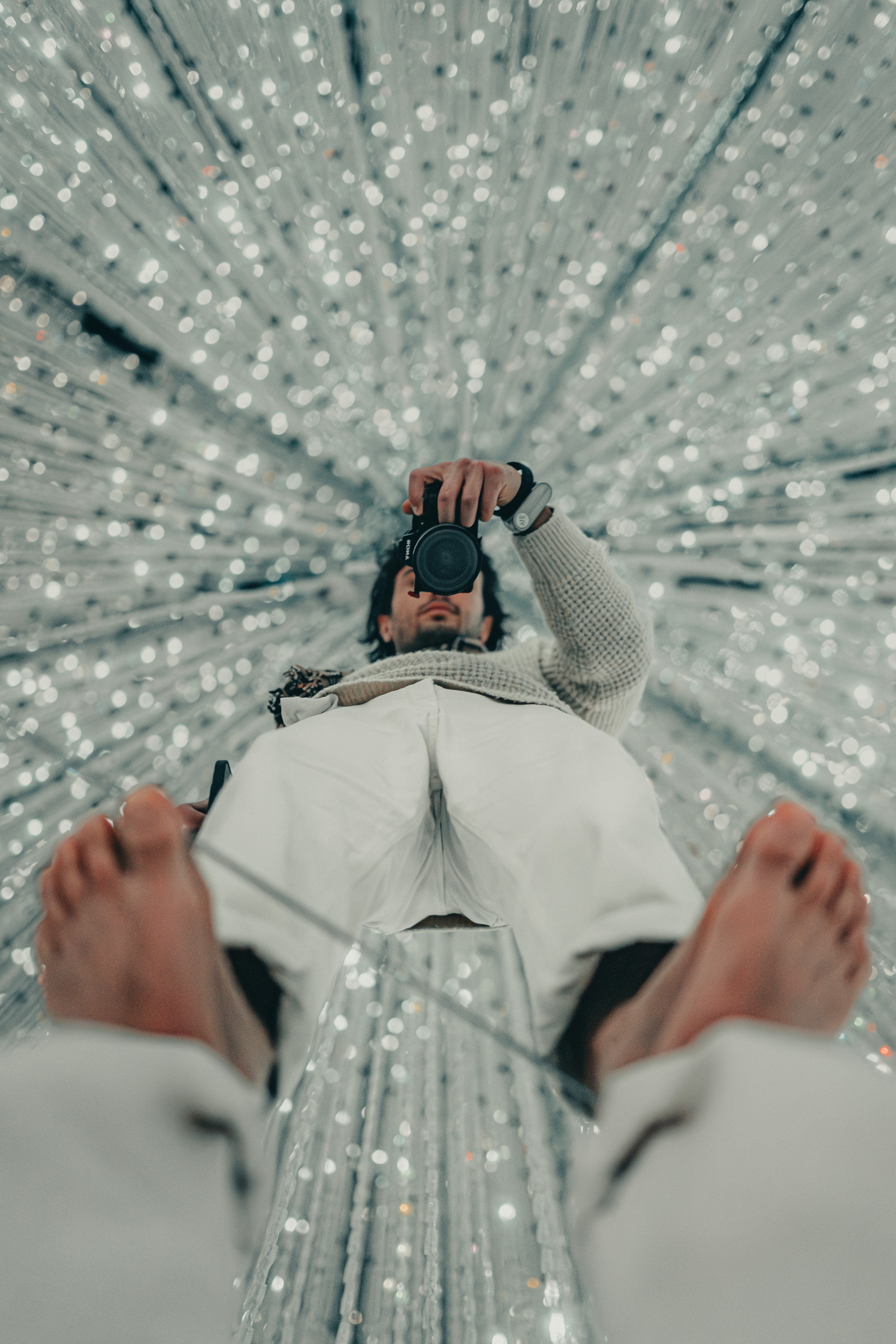 Ig @sir.simo | Man taking a selfie in a room of lights