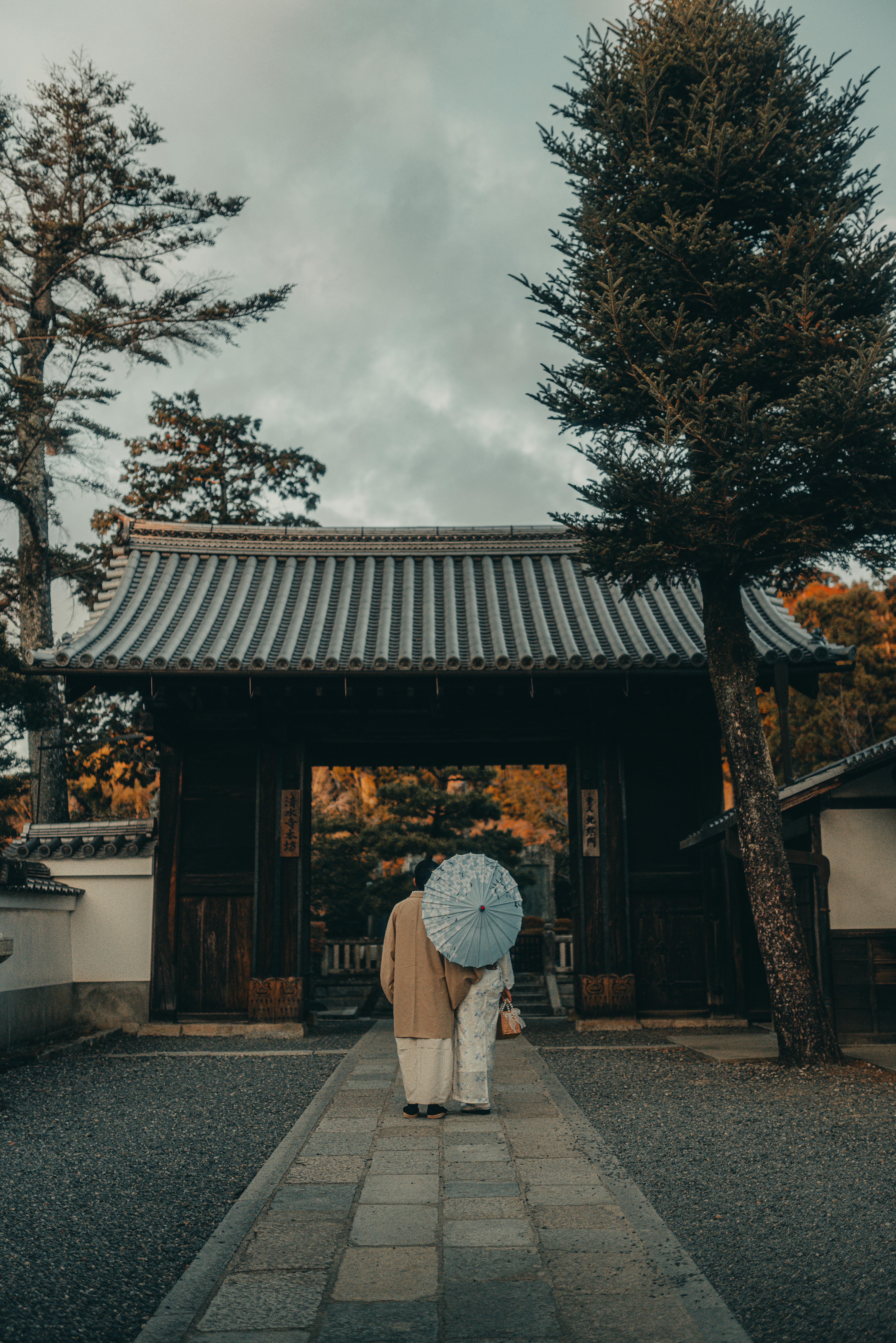 Two people with umbrella walk towards temple gate photo – Free Travel ...