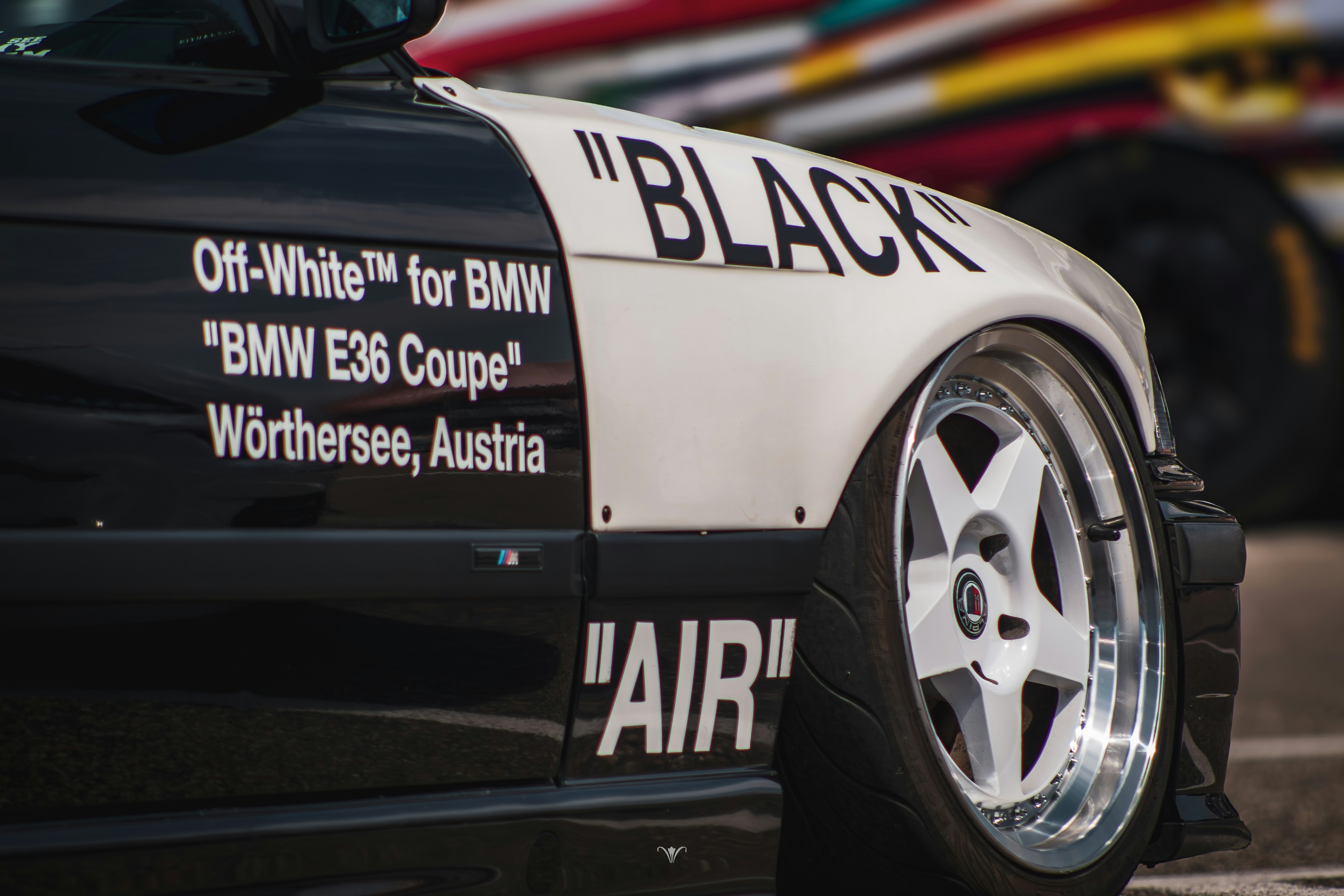 Customized BMW e36 coupe with "black" and "air" text.