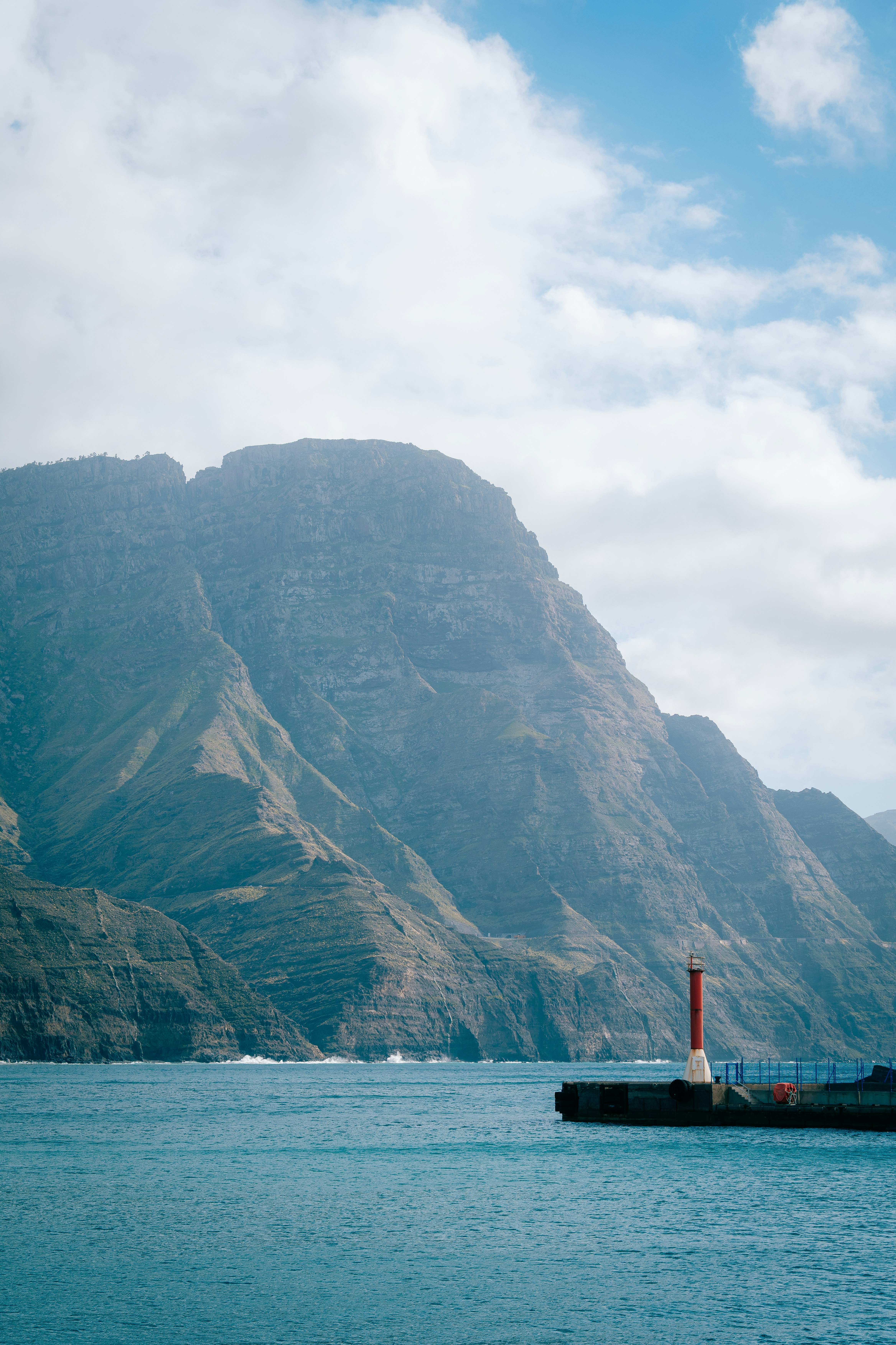 Harbor Beacon Against Majestic Peaks
