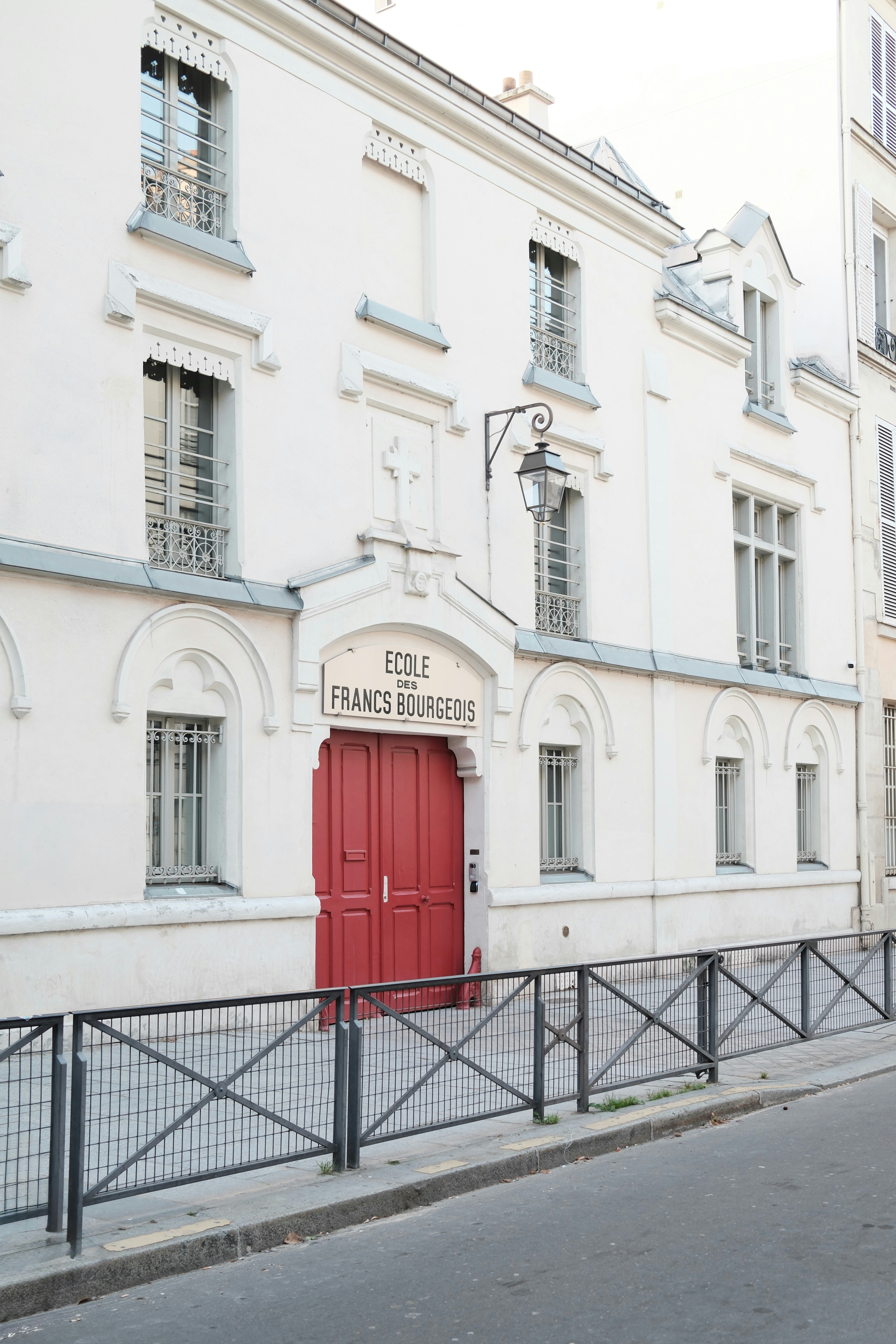 White building with red doors and windows