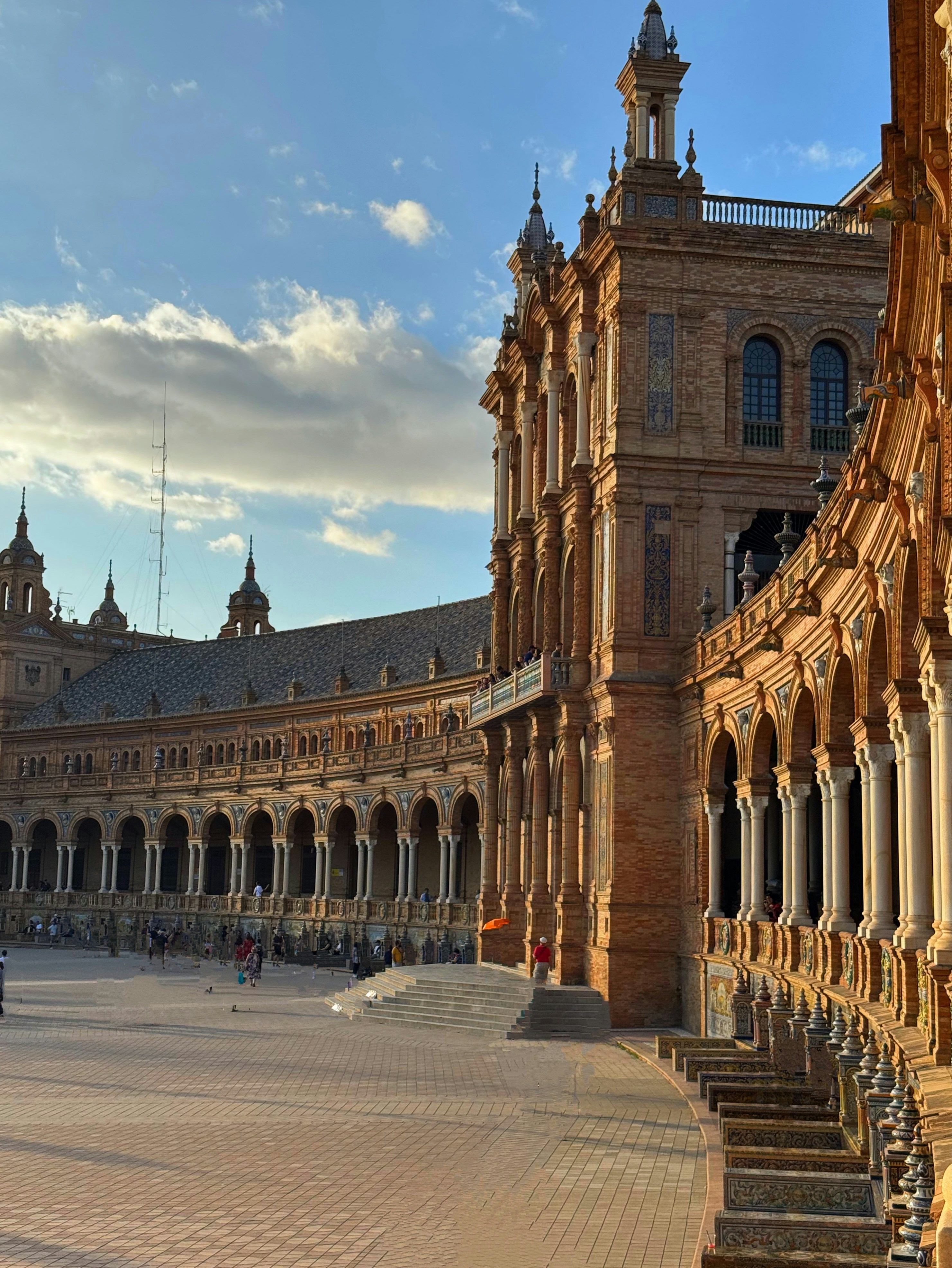 Ornate brick building with arched colonnades under sky