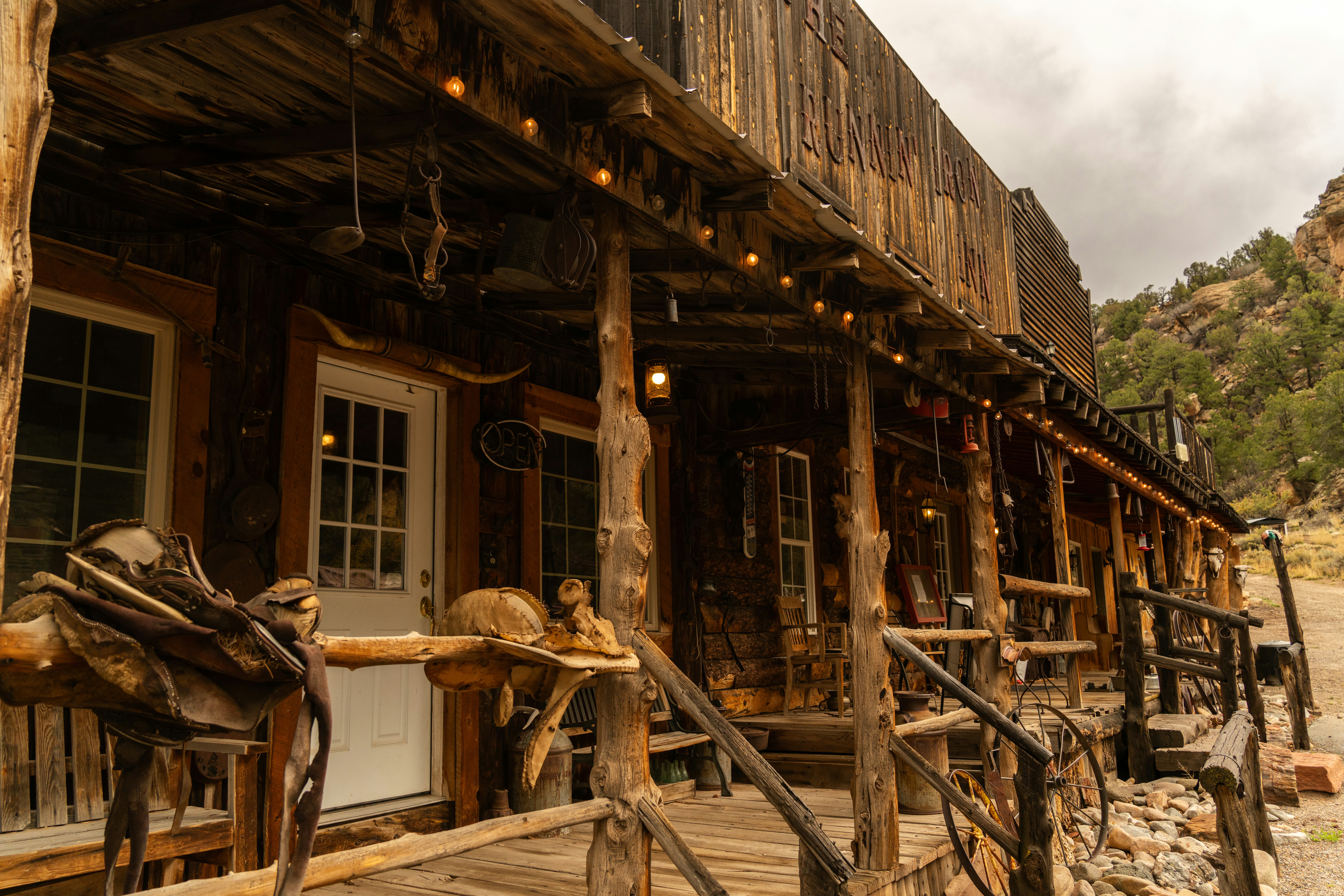 Rustic wooden building with a porch and saddle.