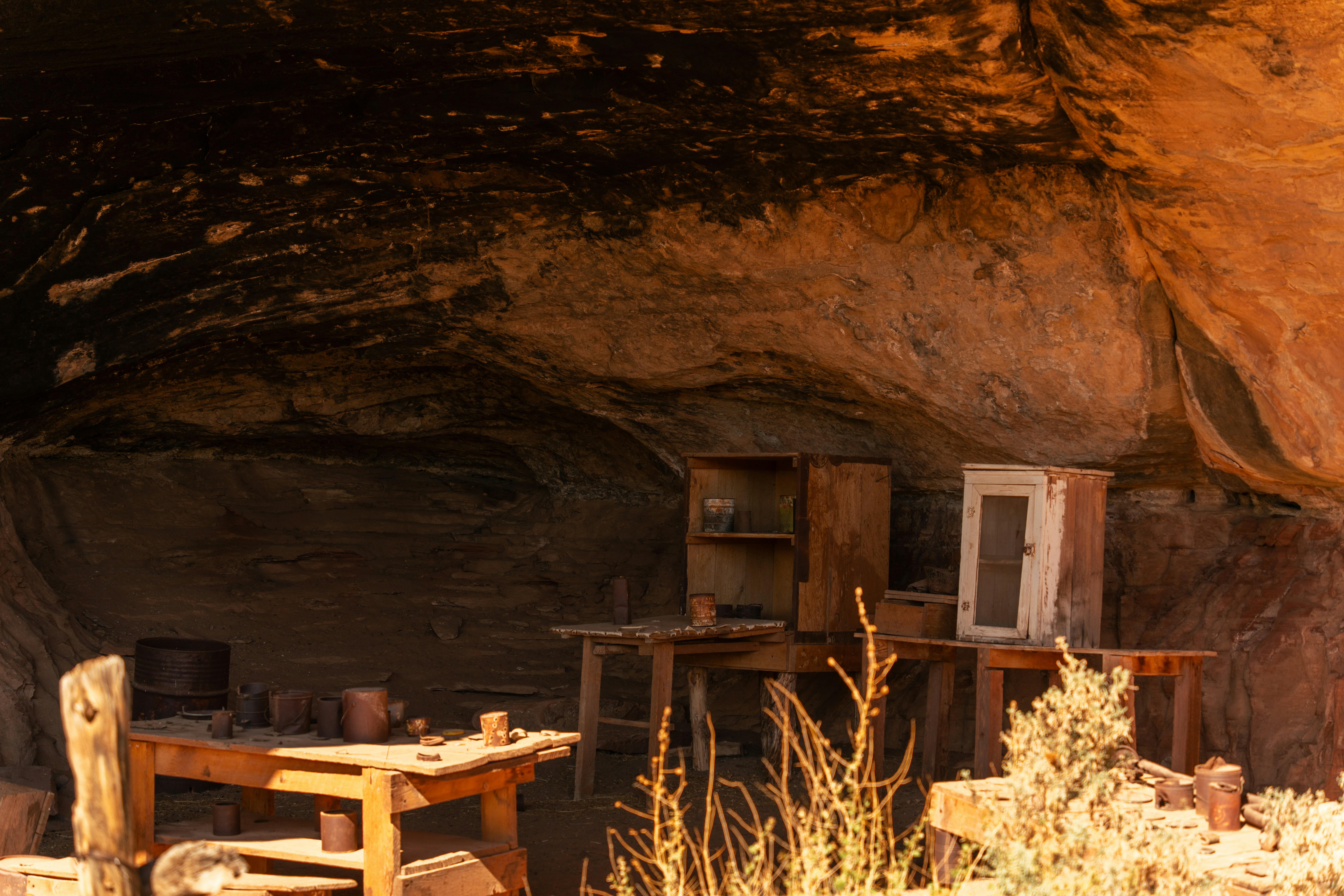 Abandoned furniture inside a rocky cave dwelling