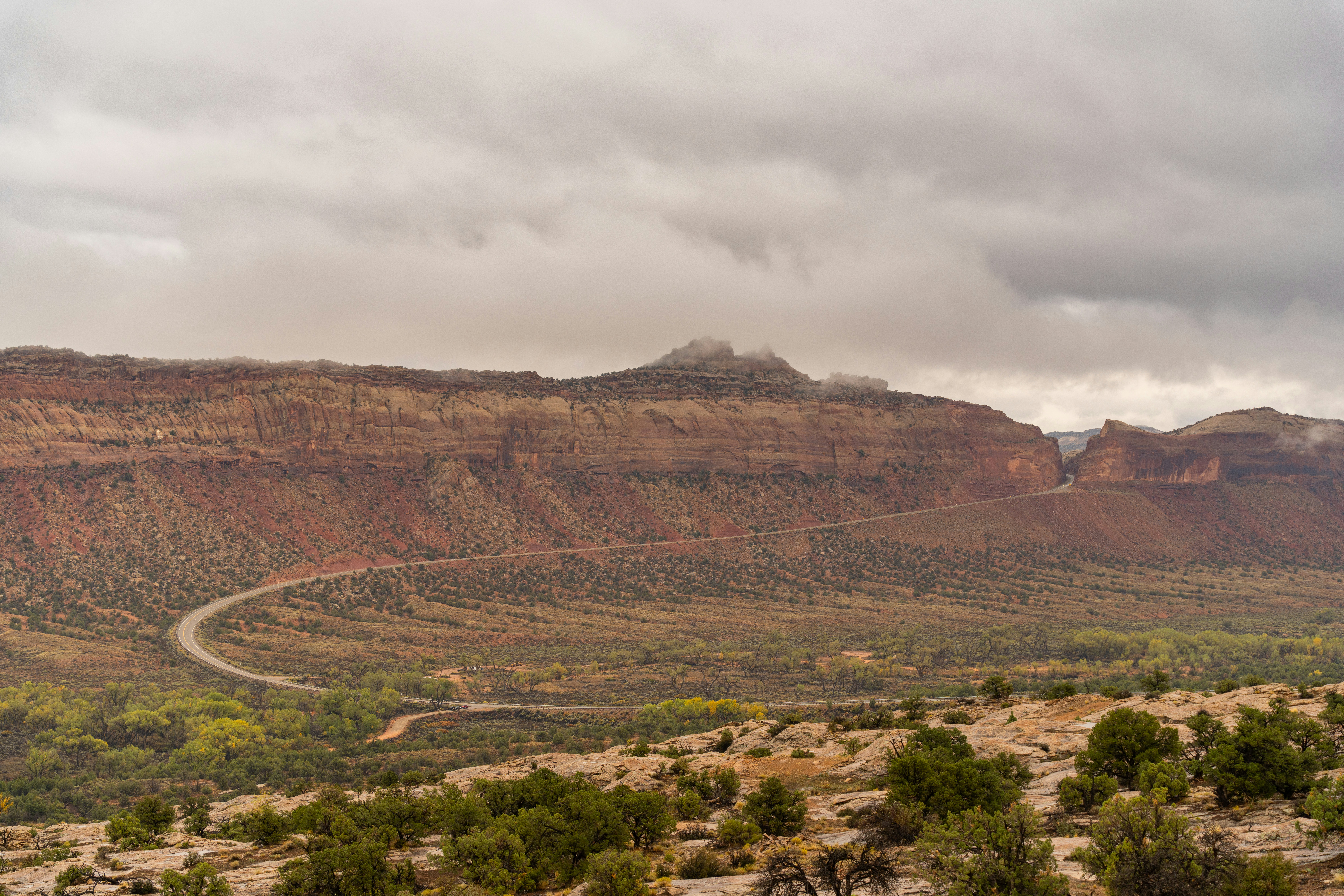 Winding road through a desert canyon landscape.
