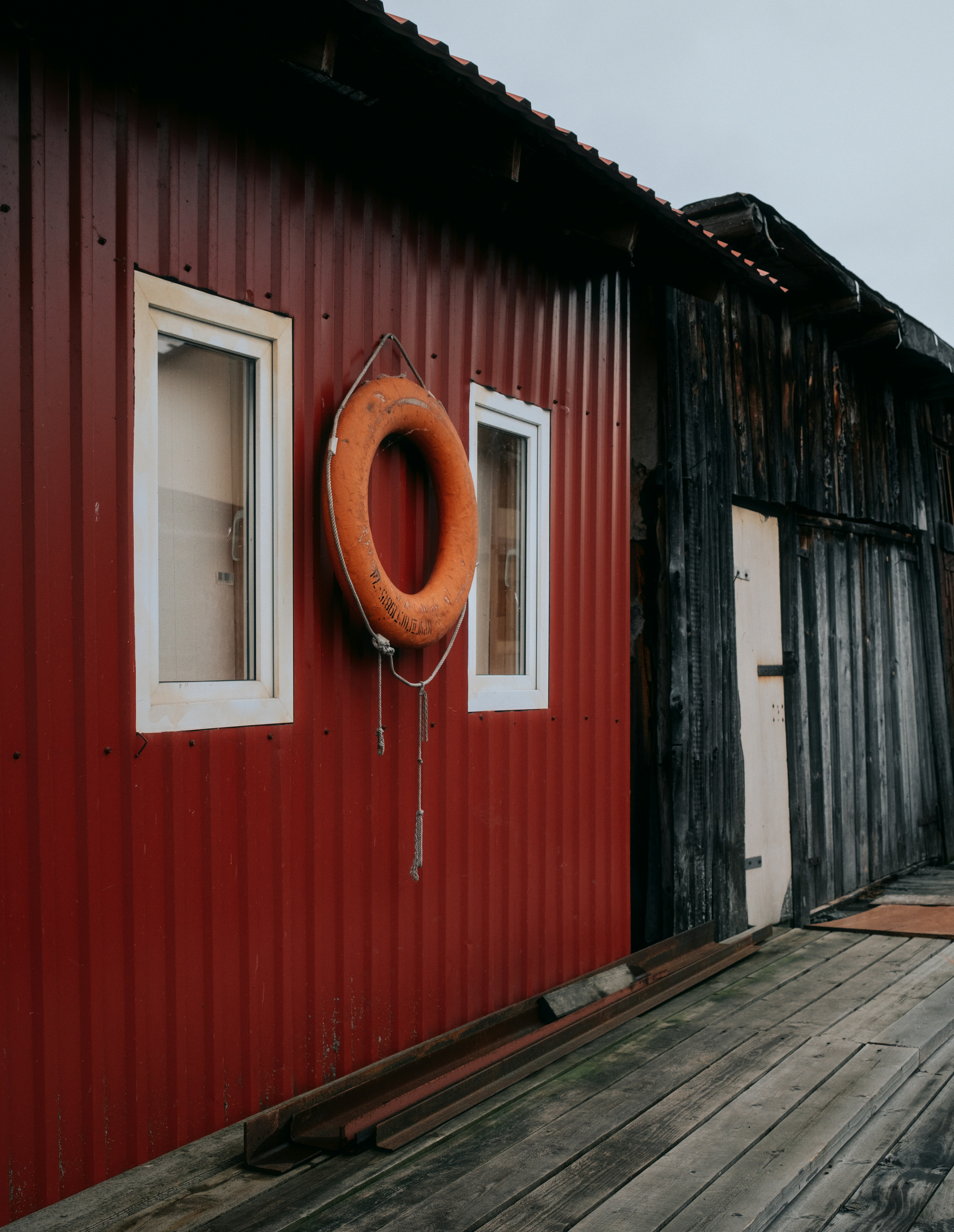 Rustic Resilience: A Lifebuoy's Vigil