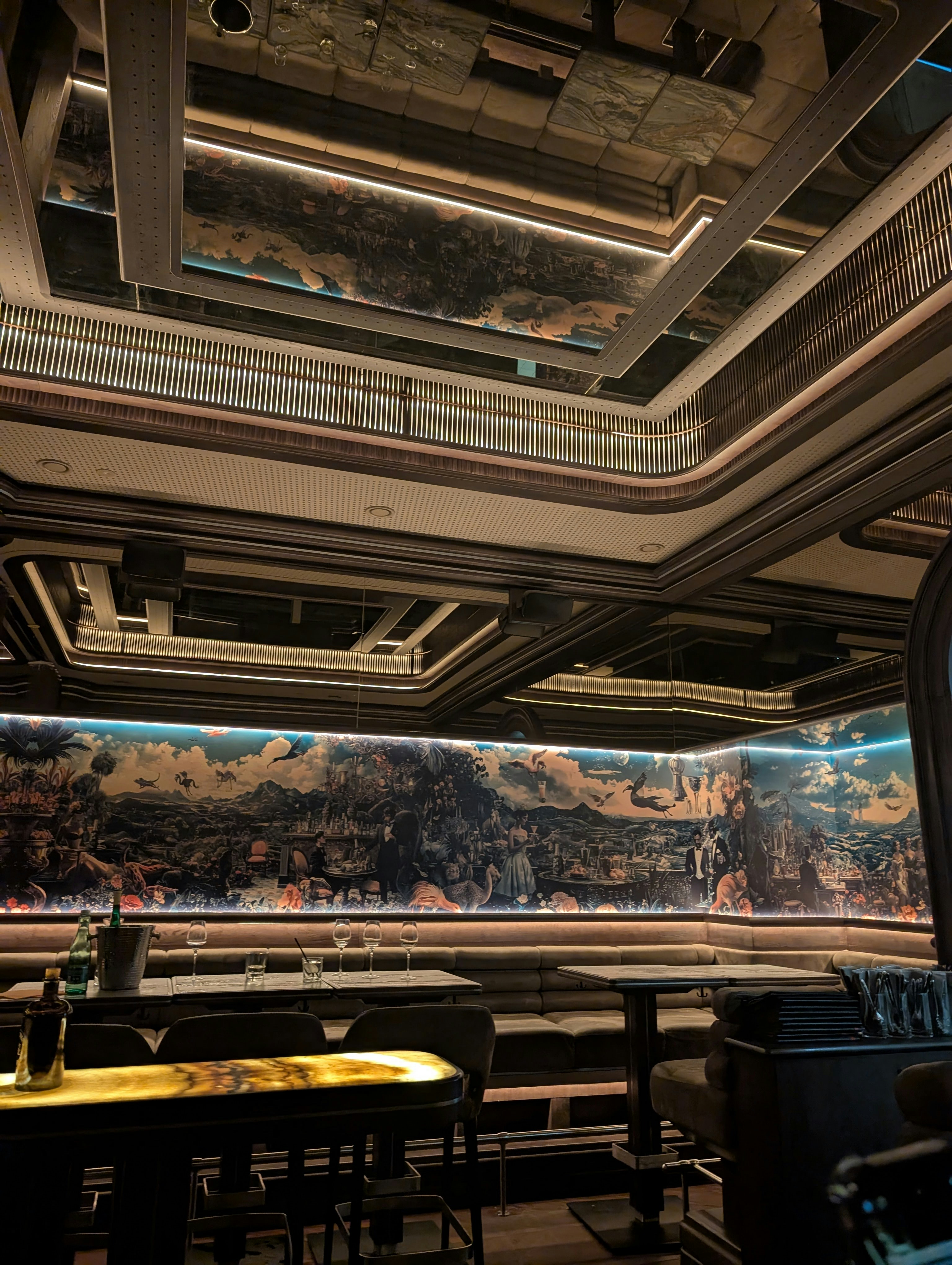 Ornate room with patterned wallpaper and reflective ceiling