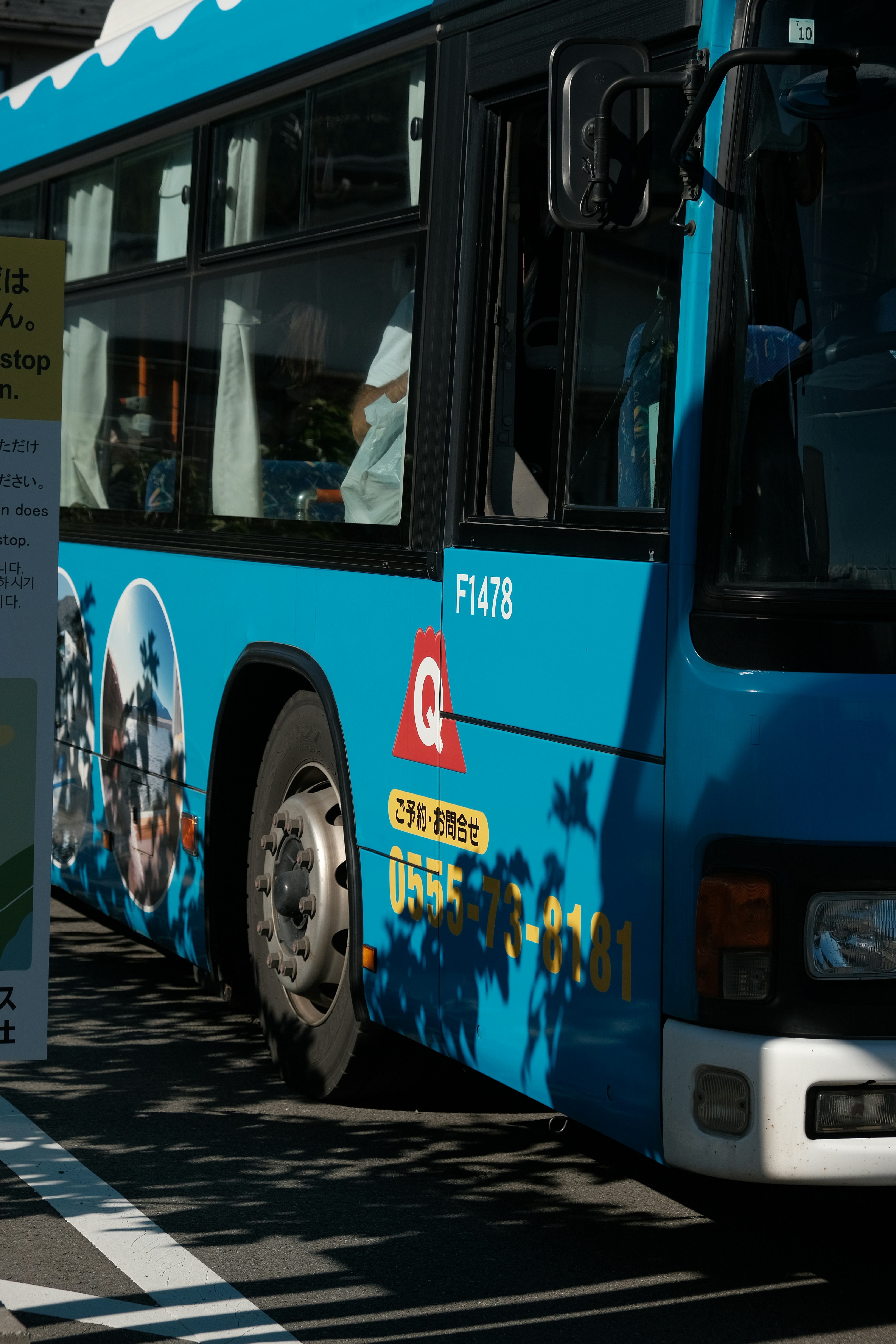 A blue bus with white lettering and logos.