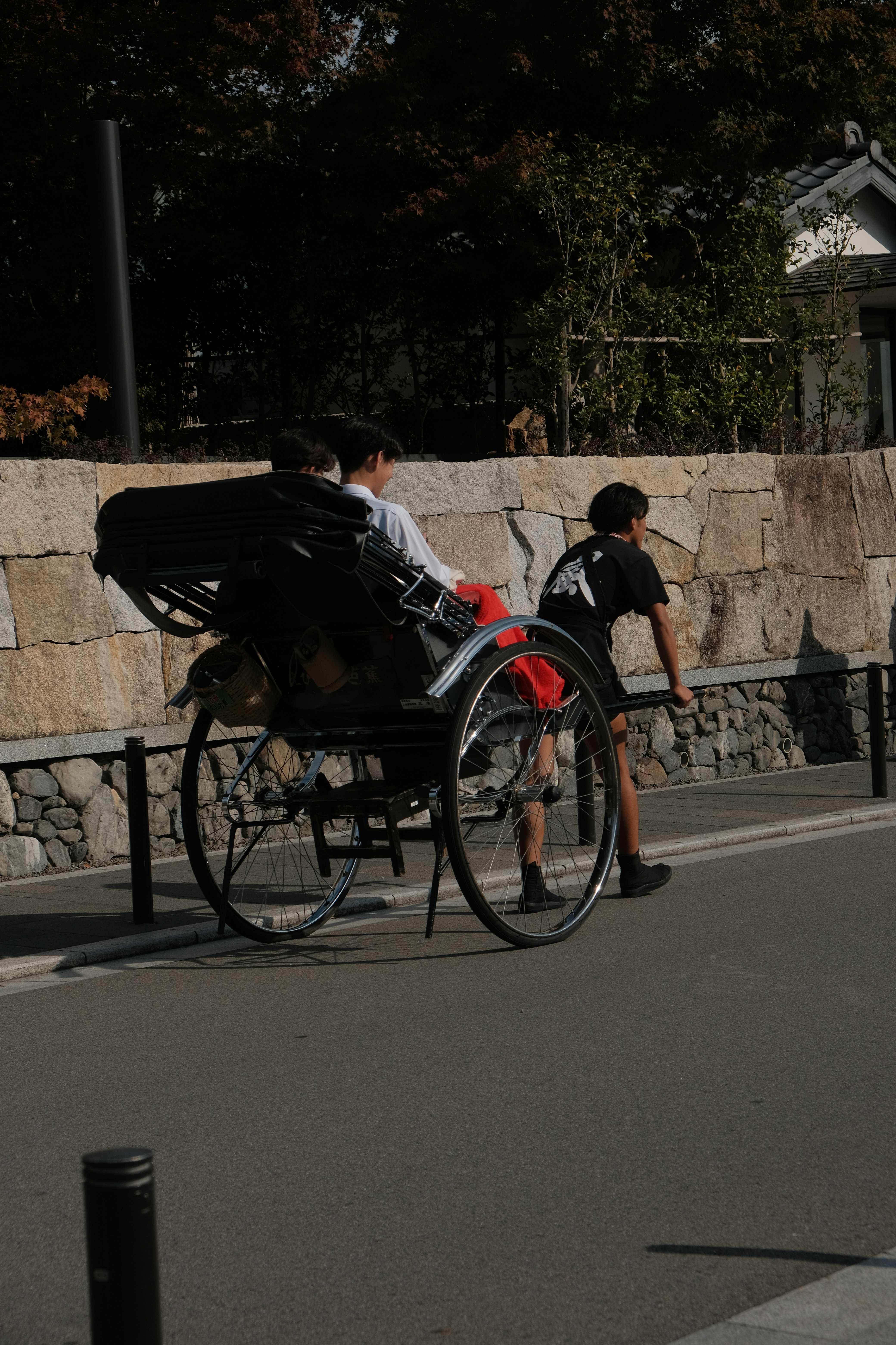 Stone-Walled Street Ride: A Rickshaw in Quiet Motion