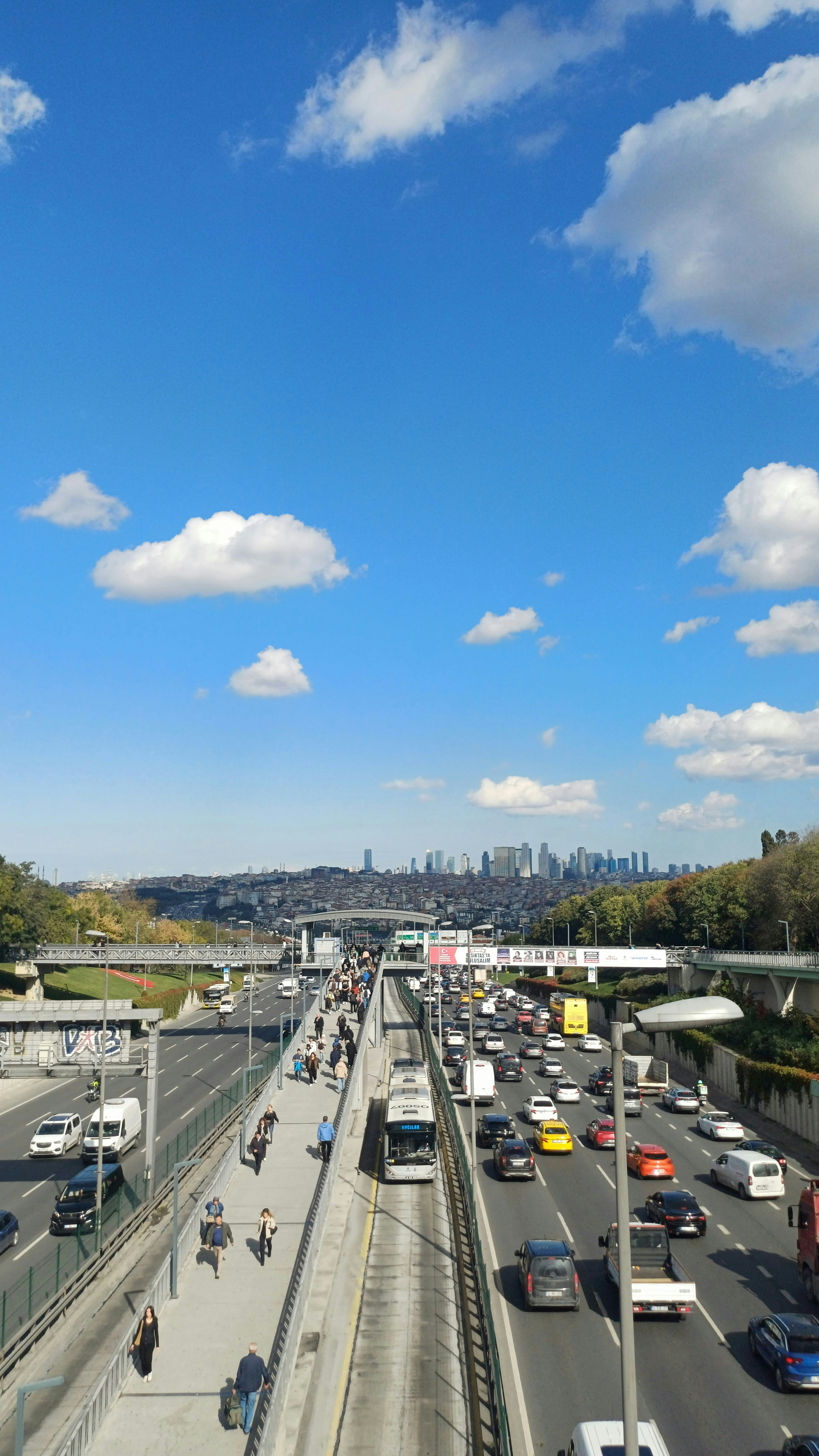 Busy highway with city skyline in the distance.