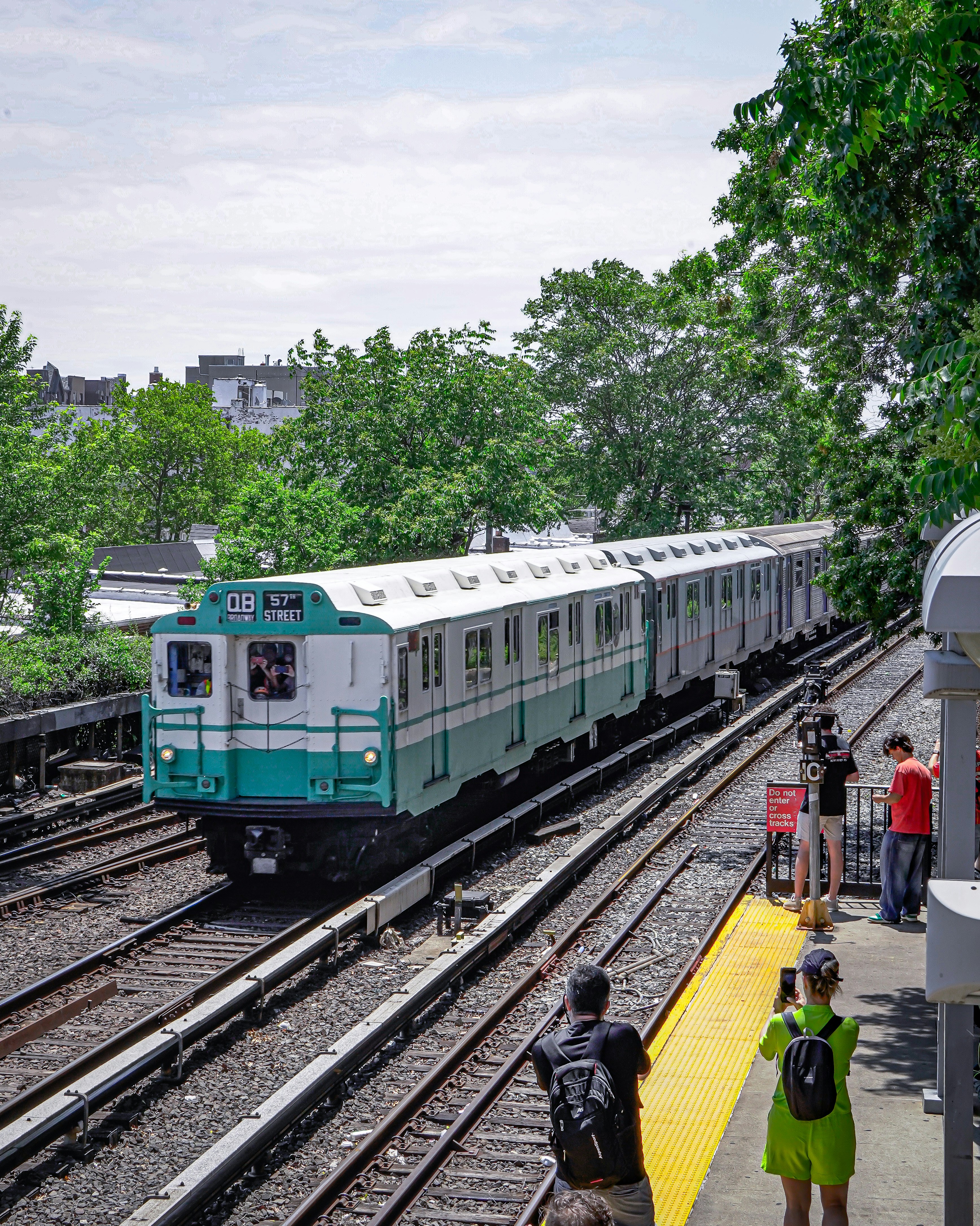 Teal CTA Train Gliding into a Sunlit City Platform