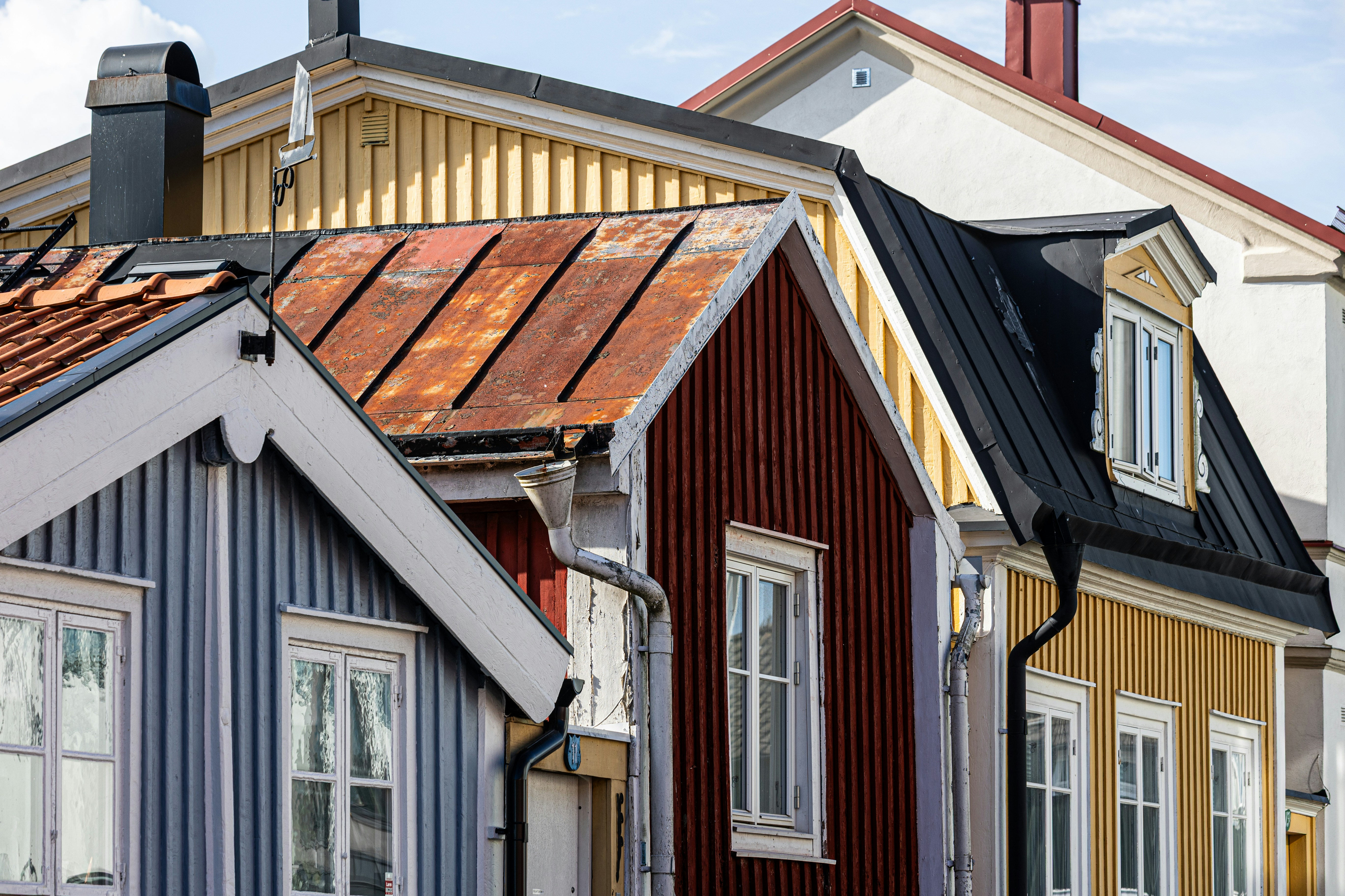 Colorful wooden houses line a street.