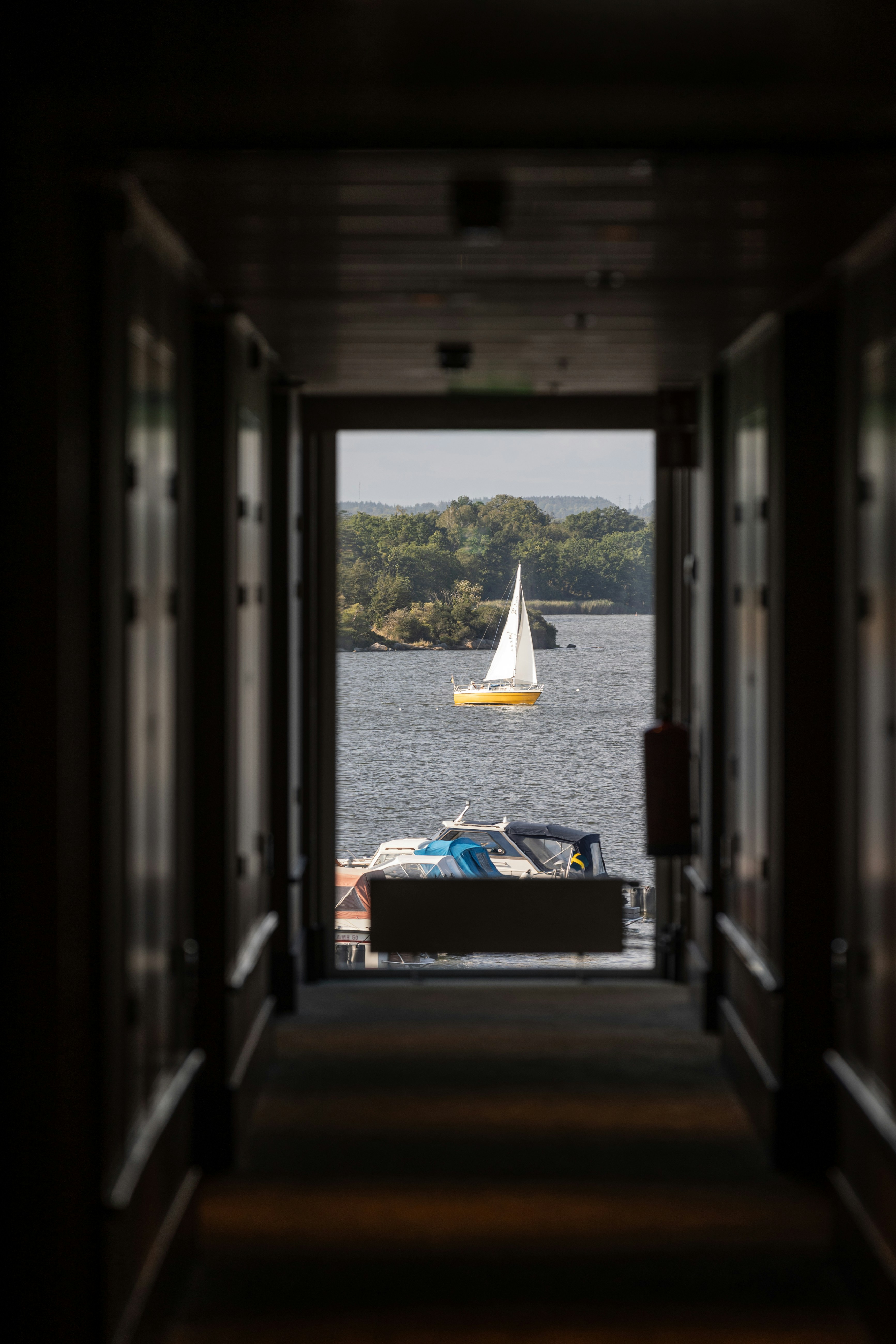 Yellow sailboat on a lake with boats