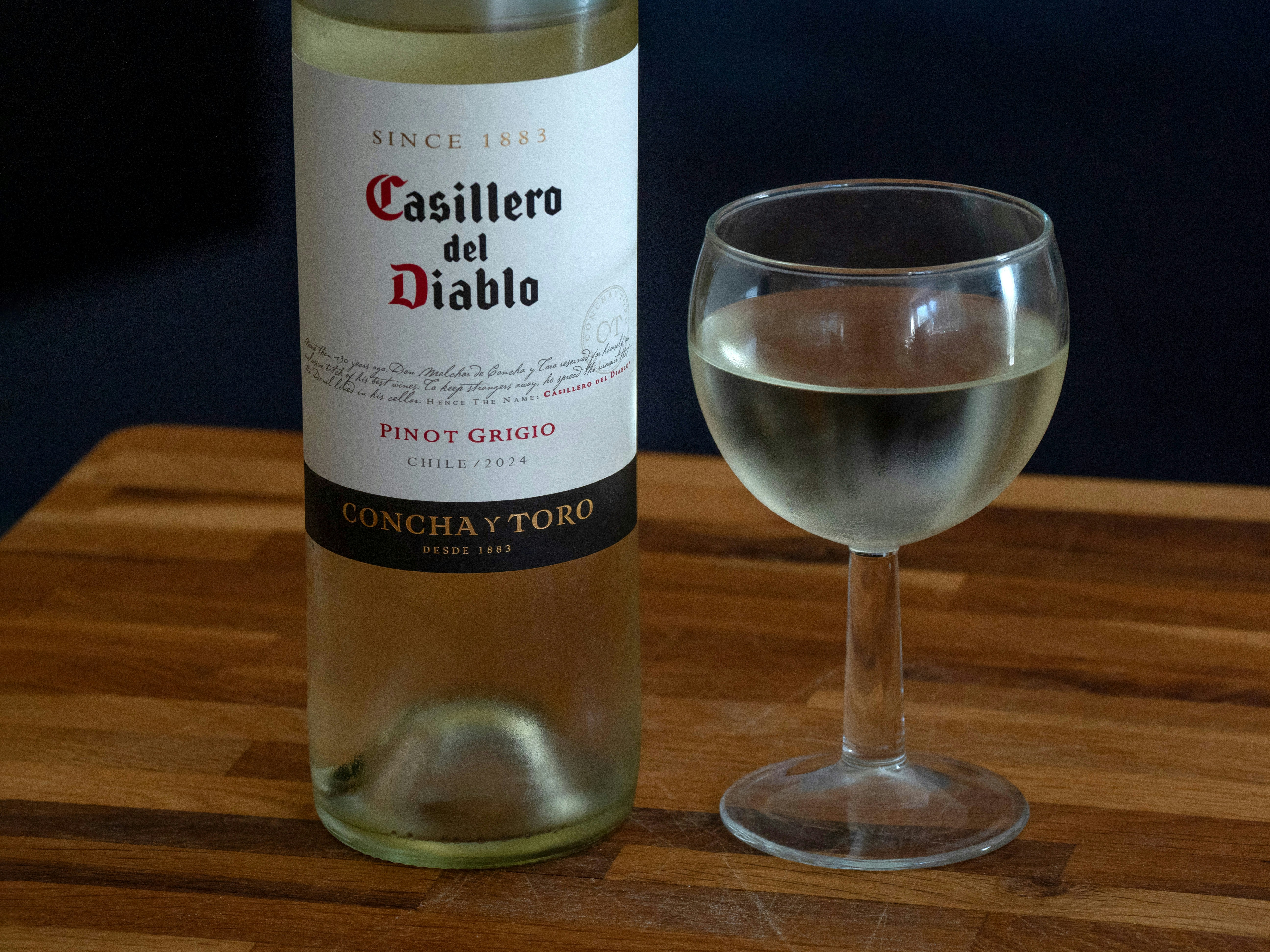 Label in Focus: Casillero del Diablo Pinot Grigio beside a glass on a wooden board