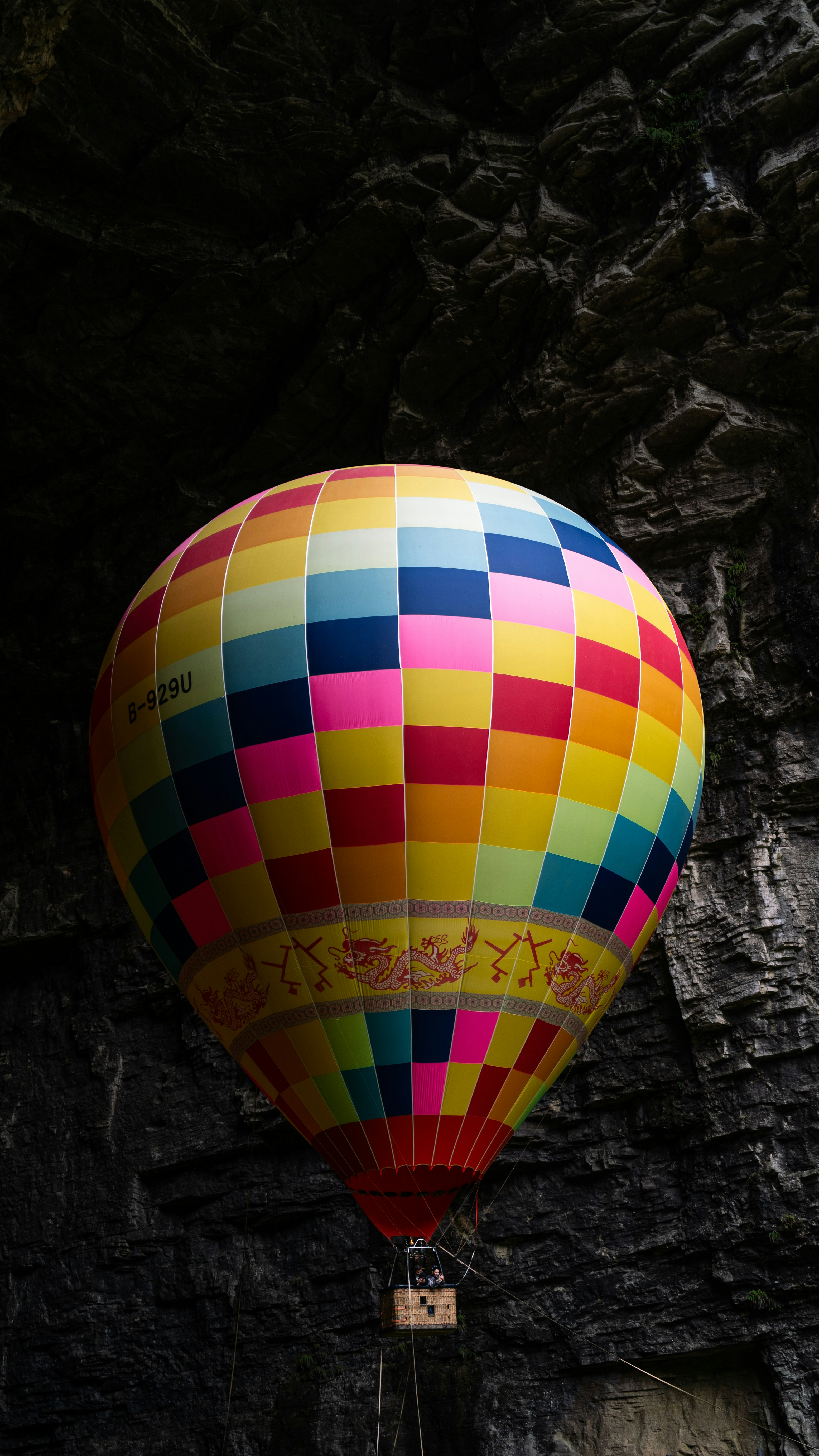 Ascendancy of Color: A Balloon's Embrace in Stone